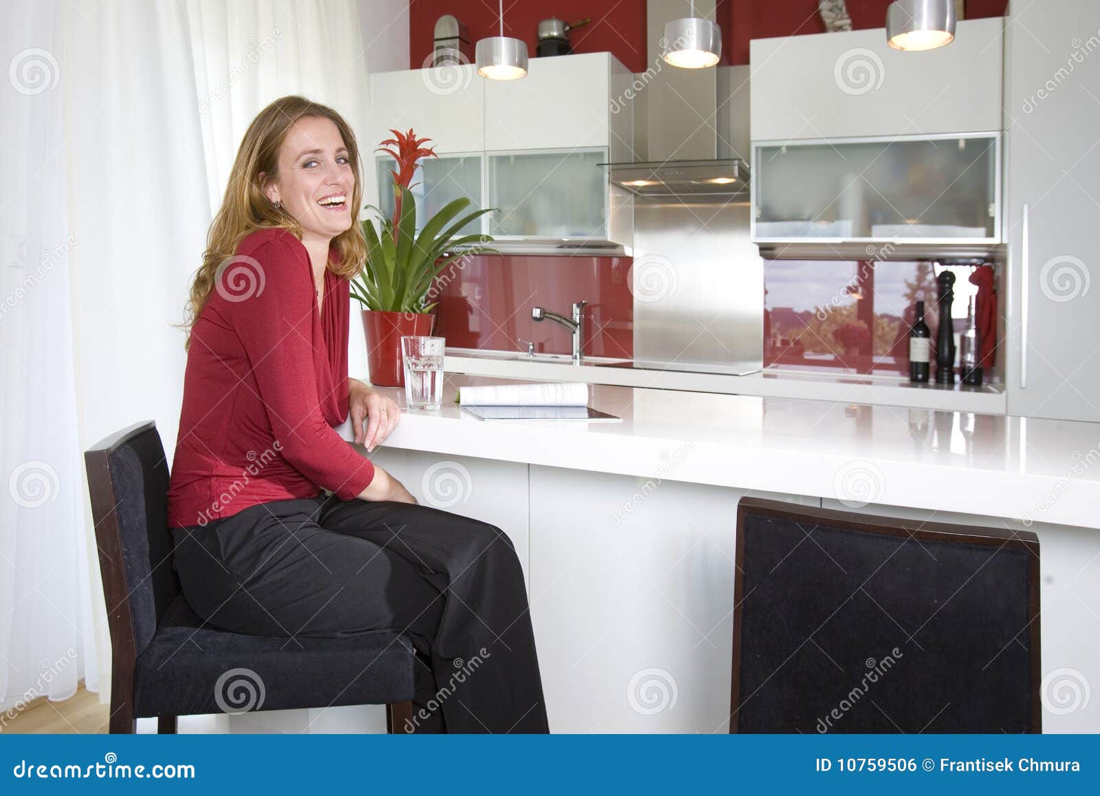 Woman in modern kitchen stock photo. Image of sitting - 10759506