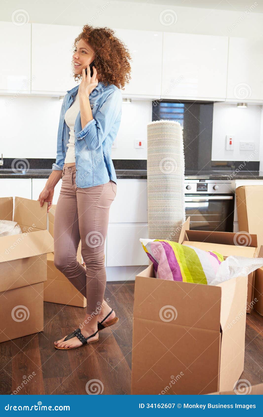 Woman Moving into New Home Talking on Mobile Phone Stock Image - Image ...
