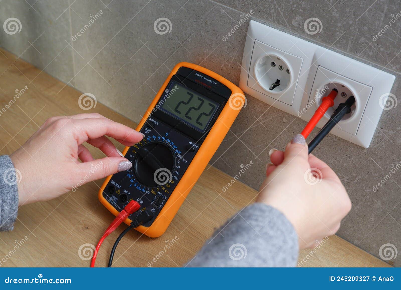 Woman with a Multimeter Check the Voltage of the Electrical Network ...