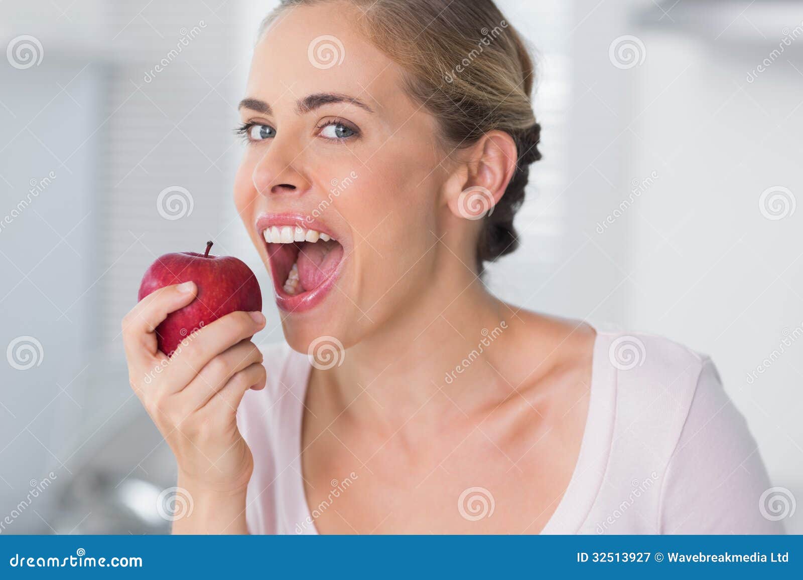 Woman munching apple stock image. Image of homey, indoors - 32513927