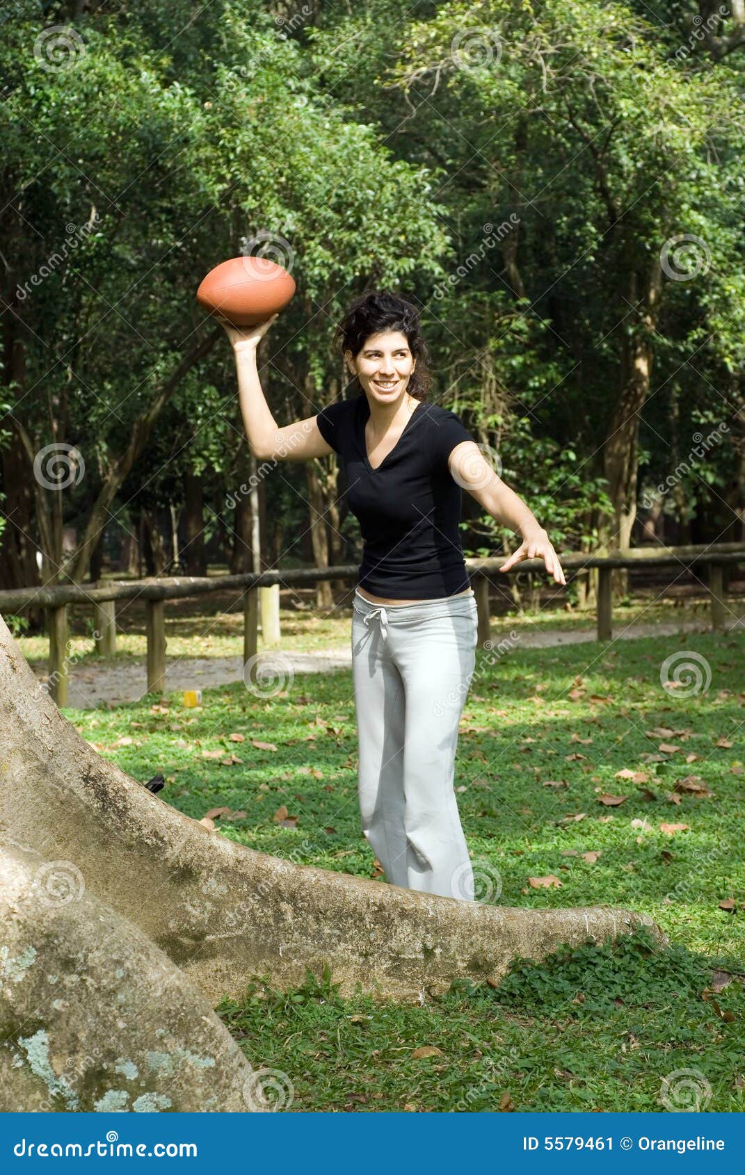 Woman Next To A Tree In A Park Throwing A Footb Picture. Image: 5579461