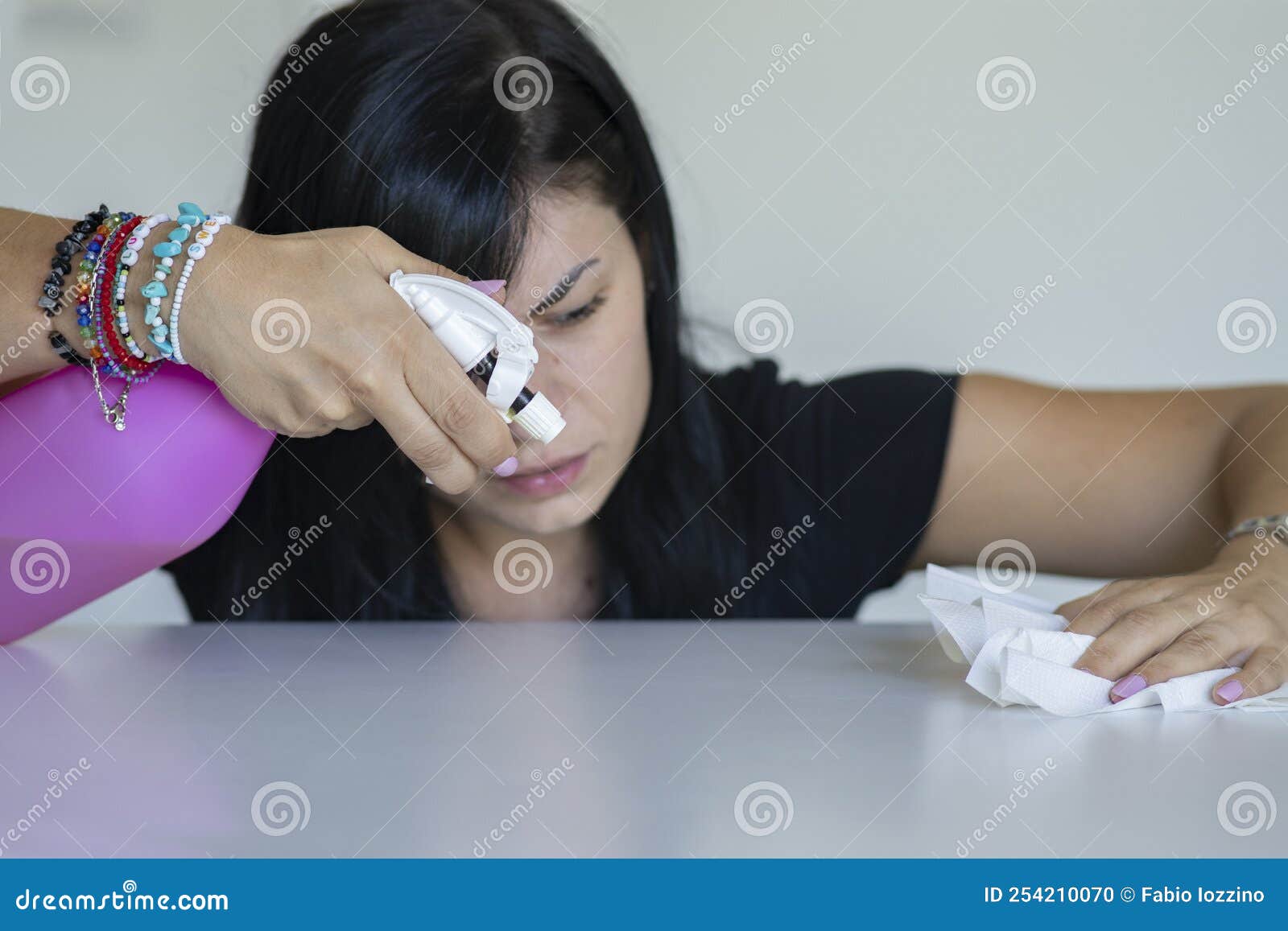 Woman with Obsessive Compulsive Disorder Cleaning Table with Detergents ...