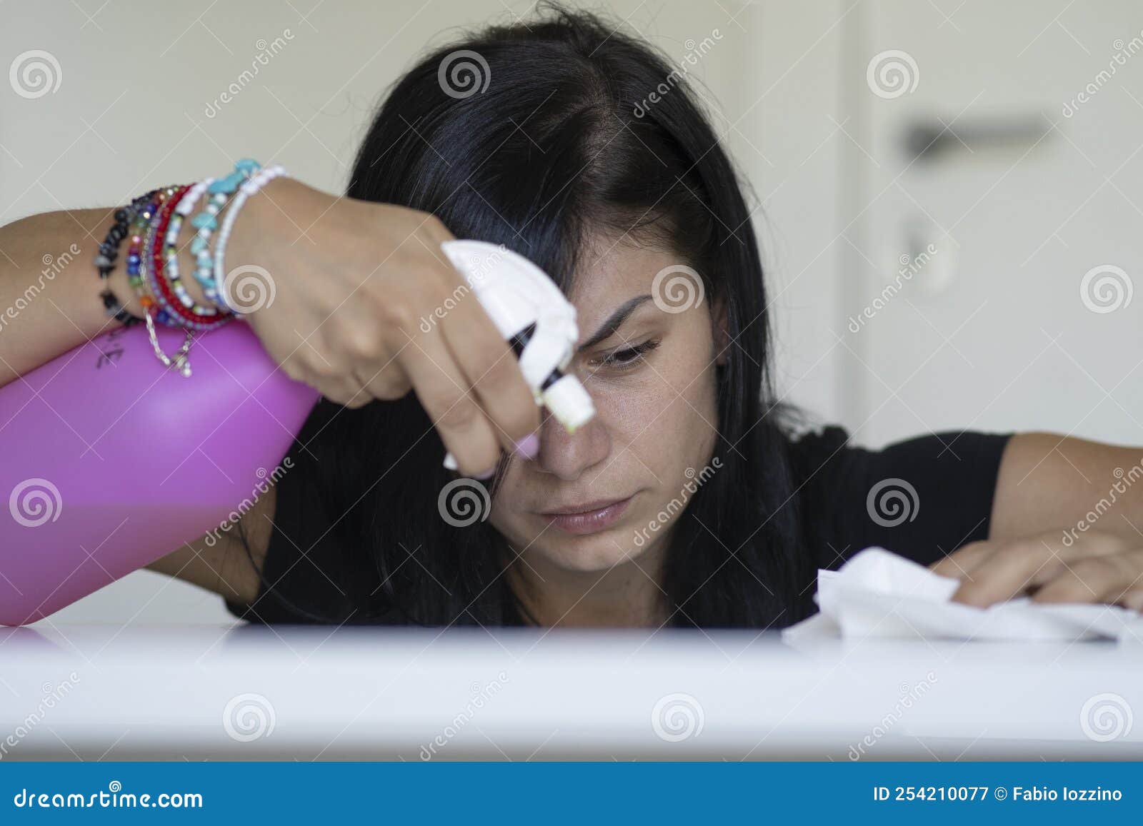 Woman with Obsessive Compulsive Disorder Cleaning Table with Detergents ...