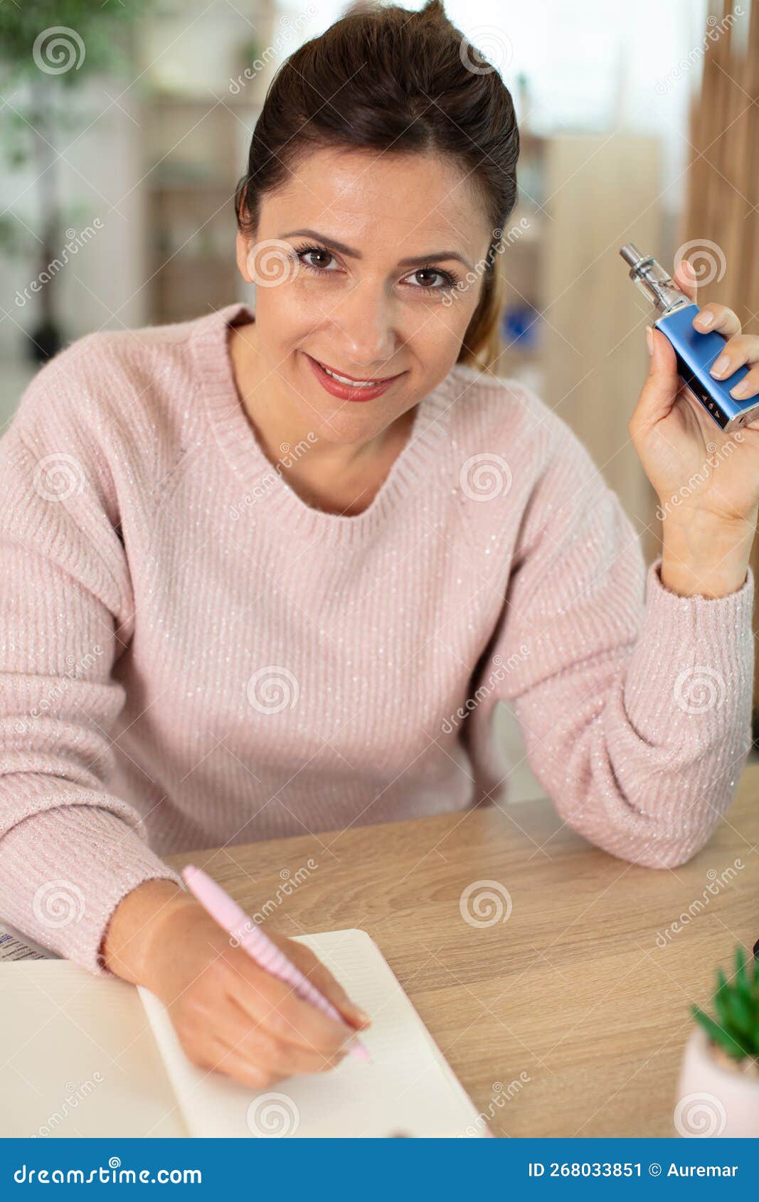 Woman in Office with Cigarette Makes Notes in Notepad Stock Image ...