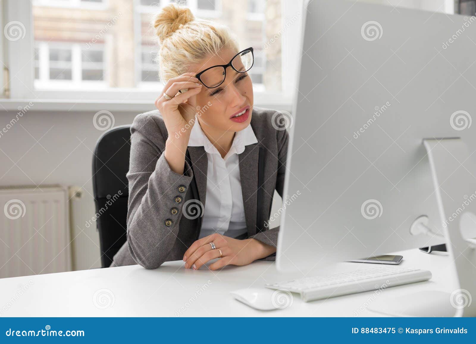 Woman at the Office Looking at Computer with Her Eyes Squeezed Stock ...