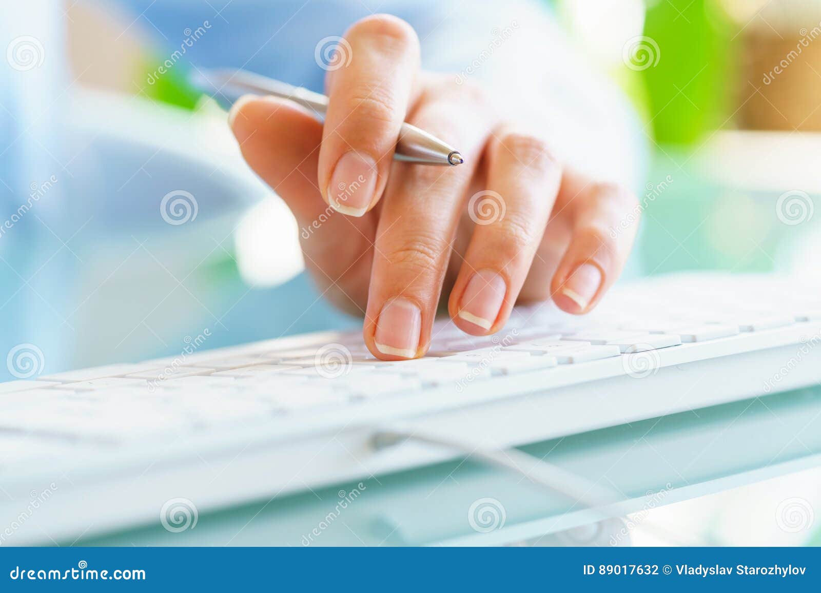 Woman Office Worker with Pen in Hand Typing on the Keyboard Stock Photo ...