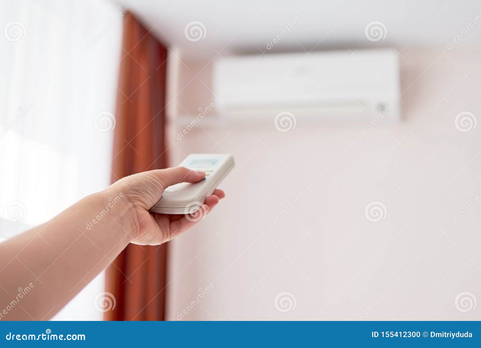 Woman Operating Remote Controller on Air Conditioner Inside the Room ...