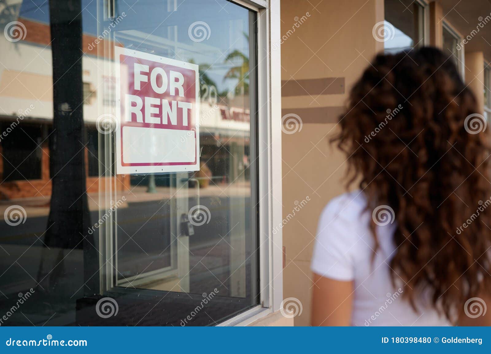 Woman outside empty store stock photo. Image of back - 180398480