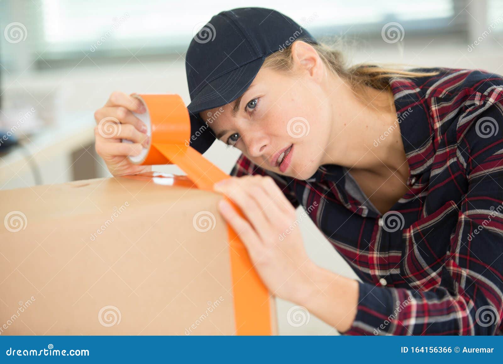 Woman packaging taping box stock photo. Image of product - 164156366