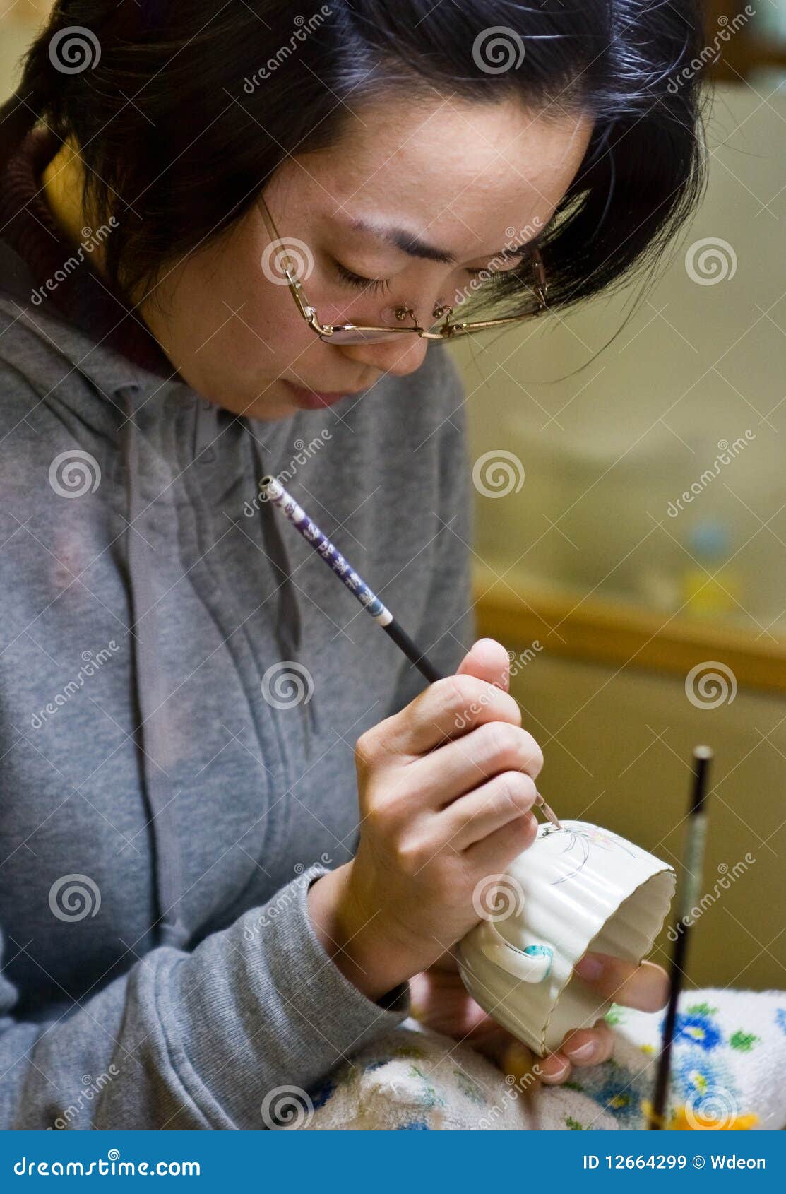 Woman painting pottery editorial stock image. Image of female - 12664299