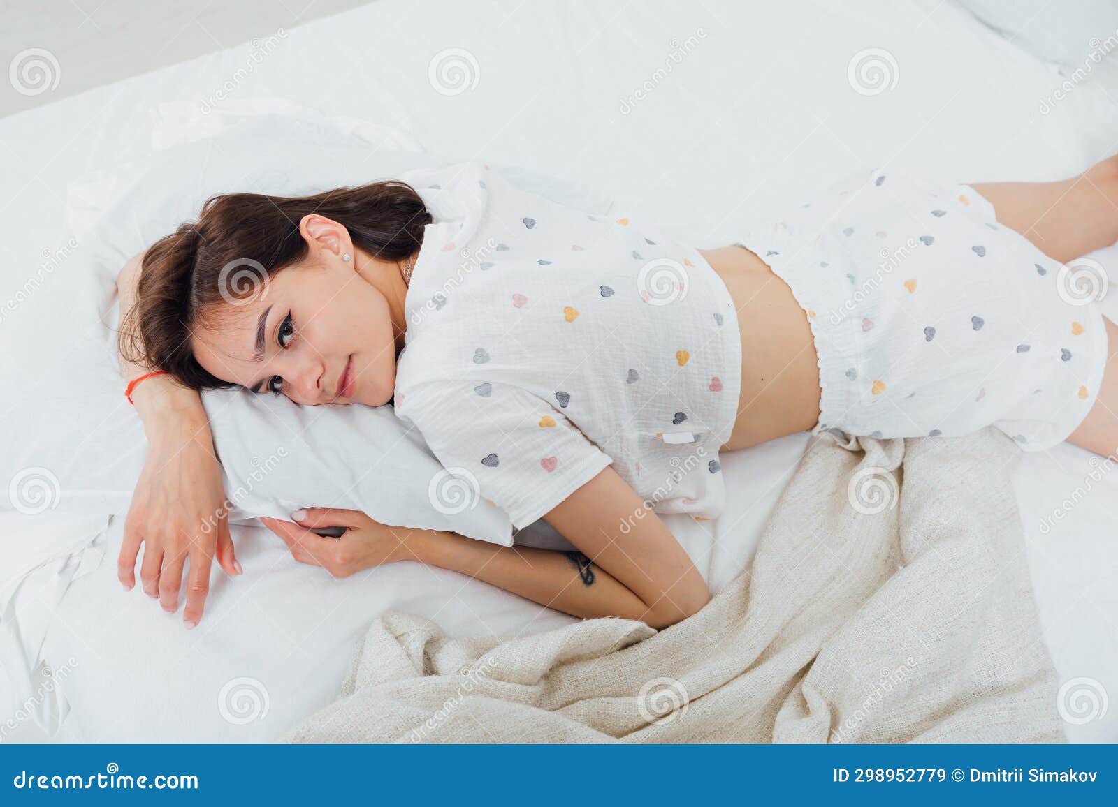 Beautiful Woman In Pajamas Sleeping In Bedroom On Bed Stock Image