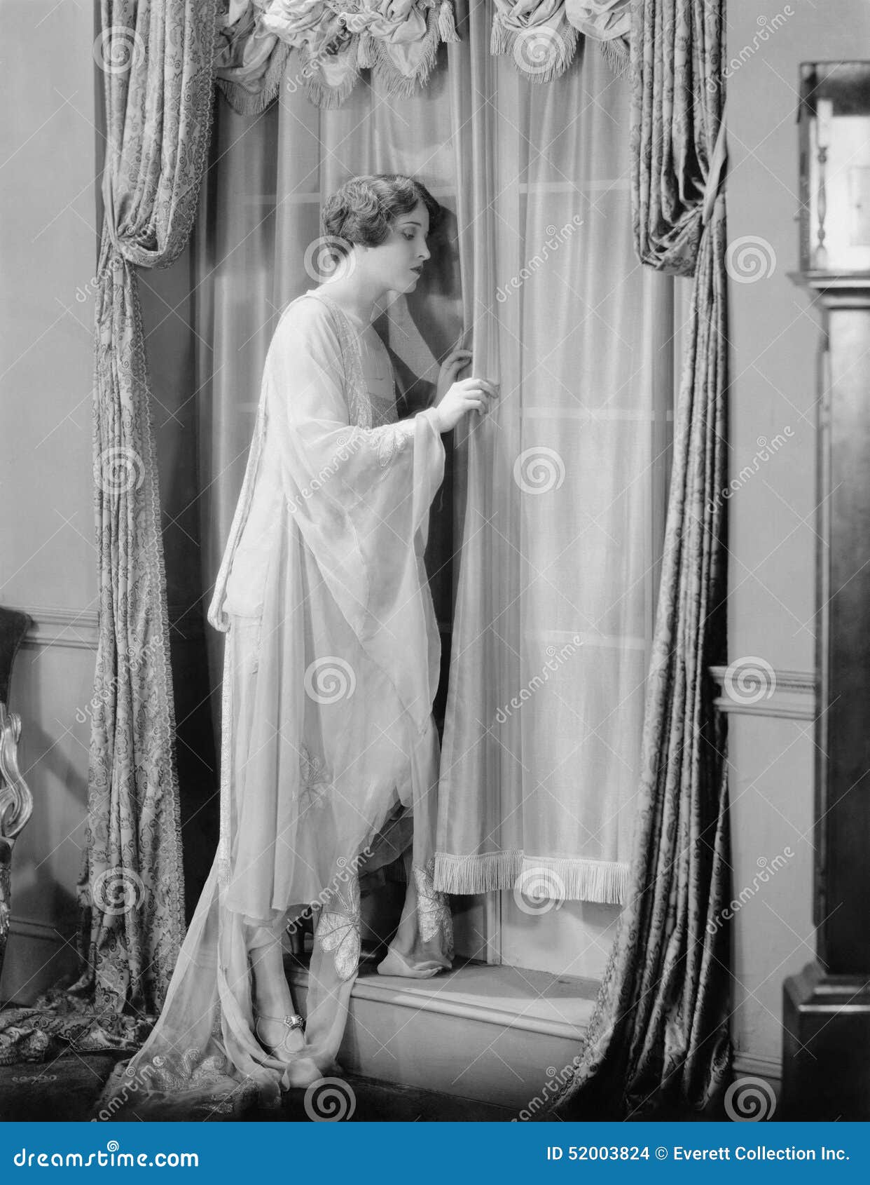 Woman peeking out window stock photo. Image of interesting - 52003824