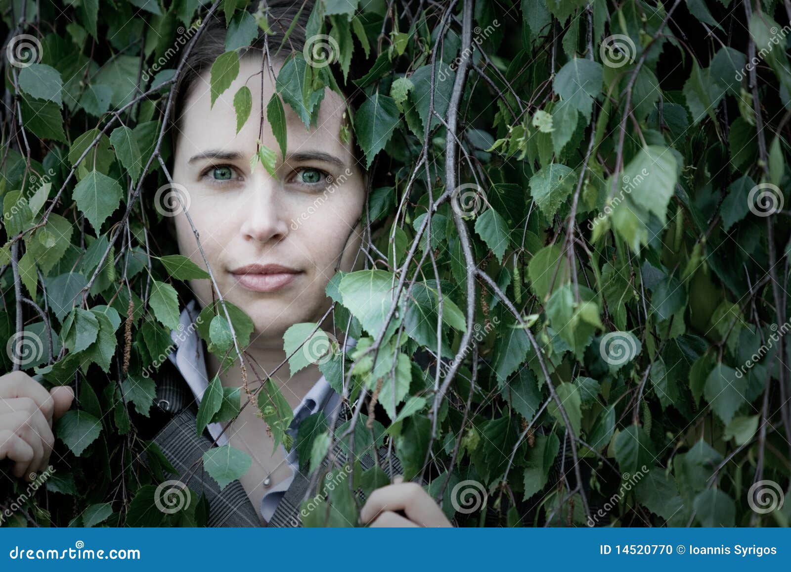 Woman Peering through Leaves Stock Photo - Image of hidden, peeking ...