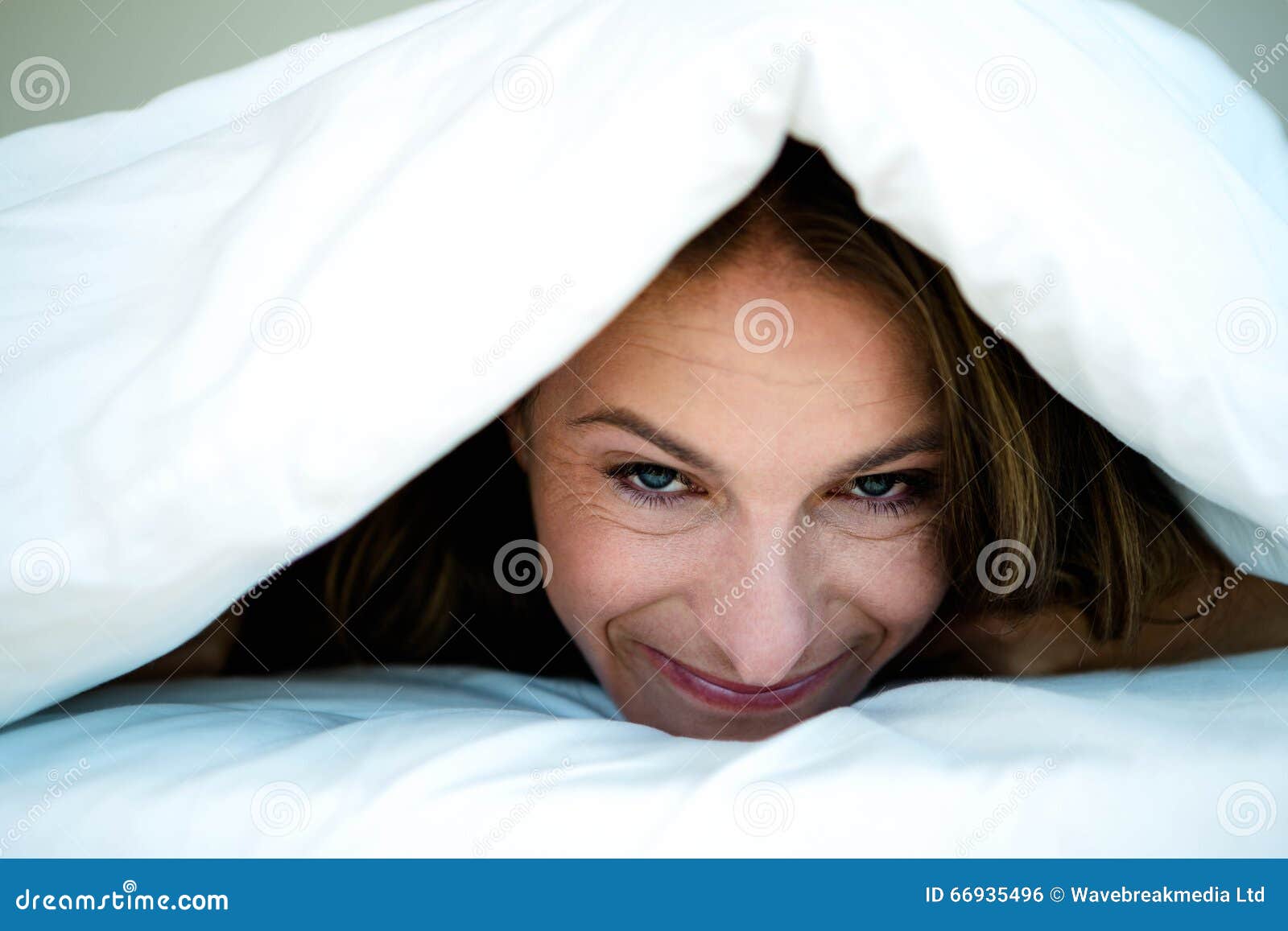Woman Peering Out from Under Her Duvet Stock Photo - Image of eyes ...
