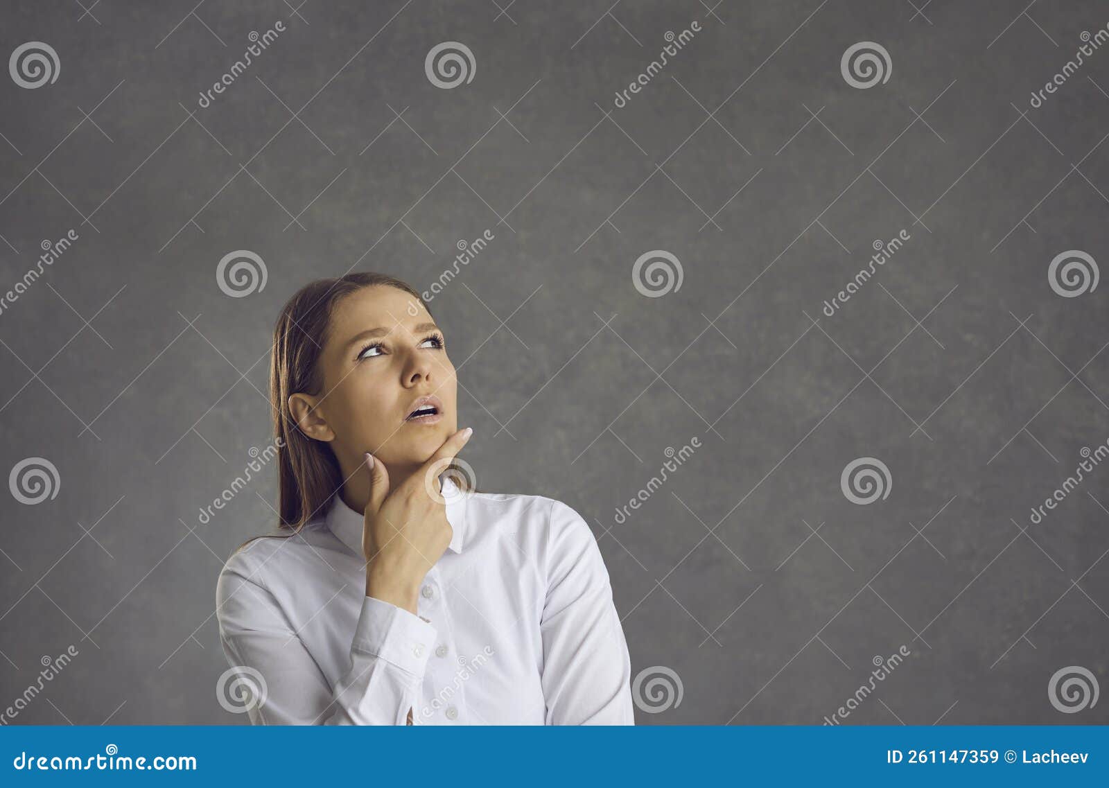 Woman with a Pensive Expression Standing on a Gray Background Thinking ...
