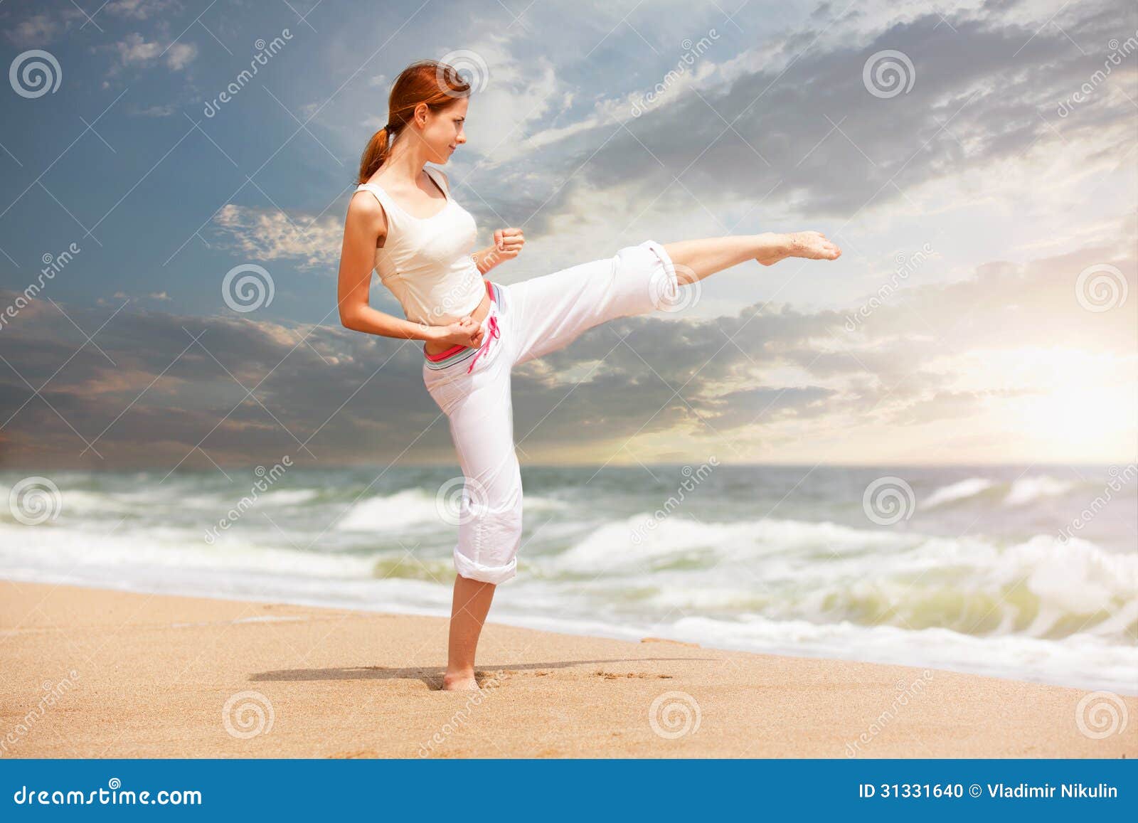 Woman performing a kick stock photo. Image of health - 31331640