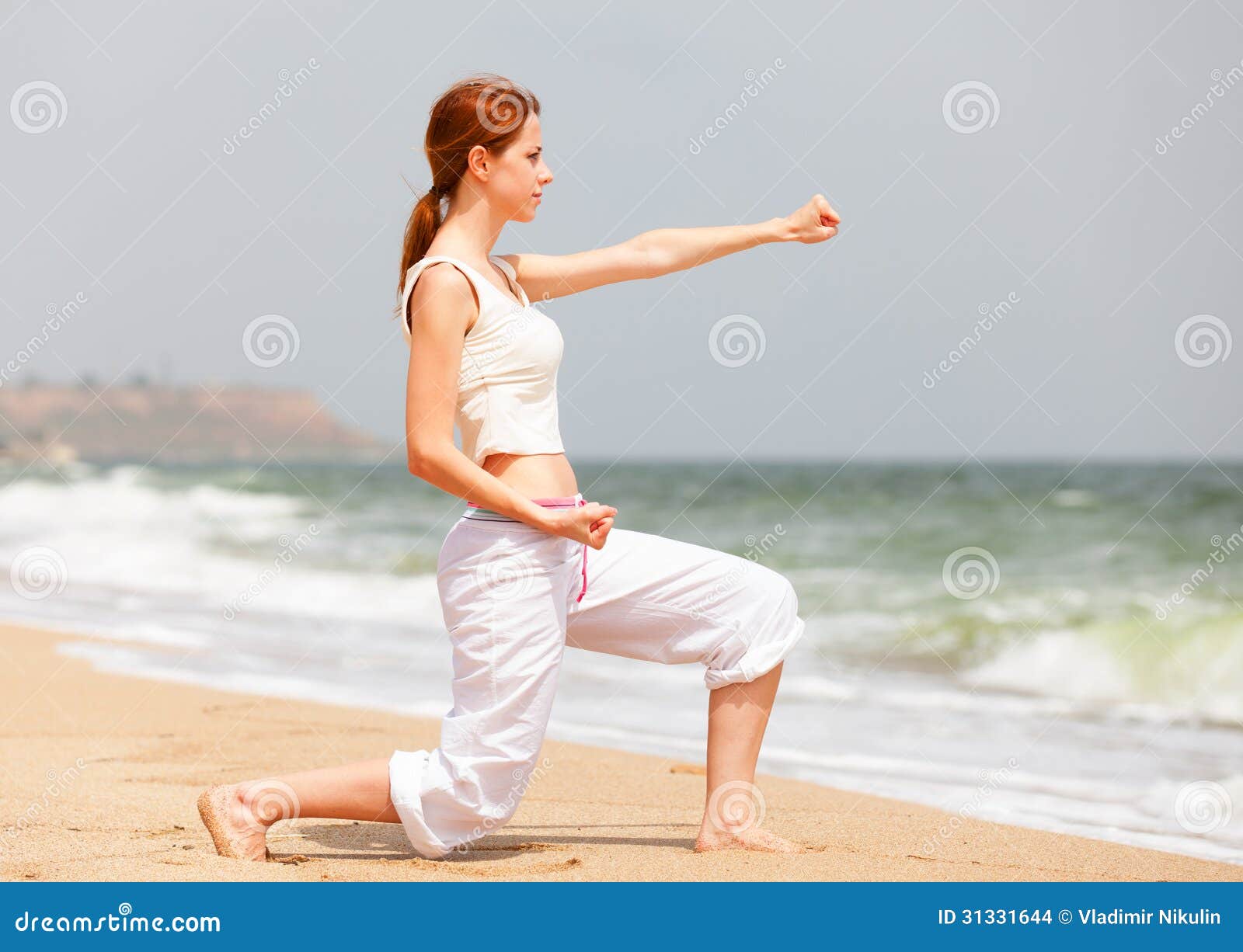 Woman performing a kick stock photo. Image of attractive - 31331644