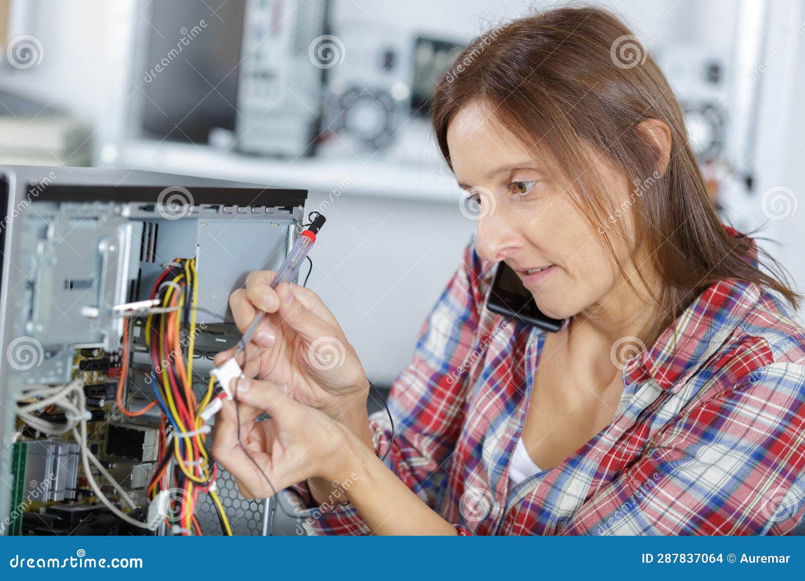 Woman on Phone Fixing Computer at Work Stock Photo - Image of checking ...