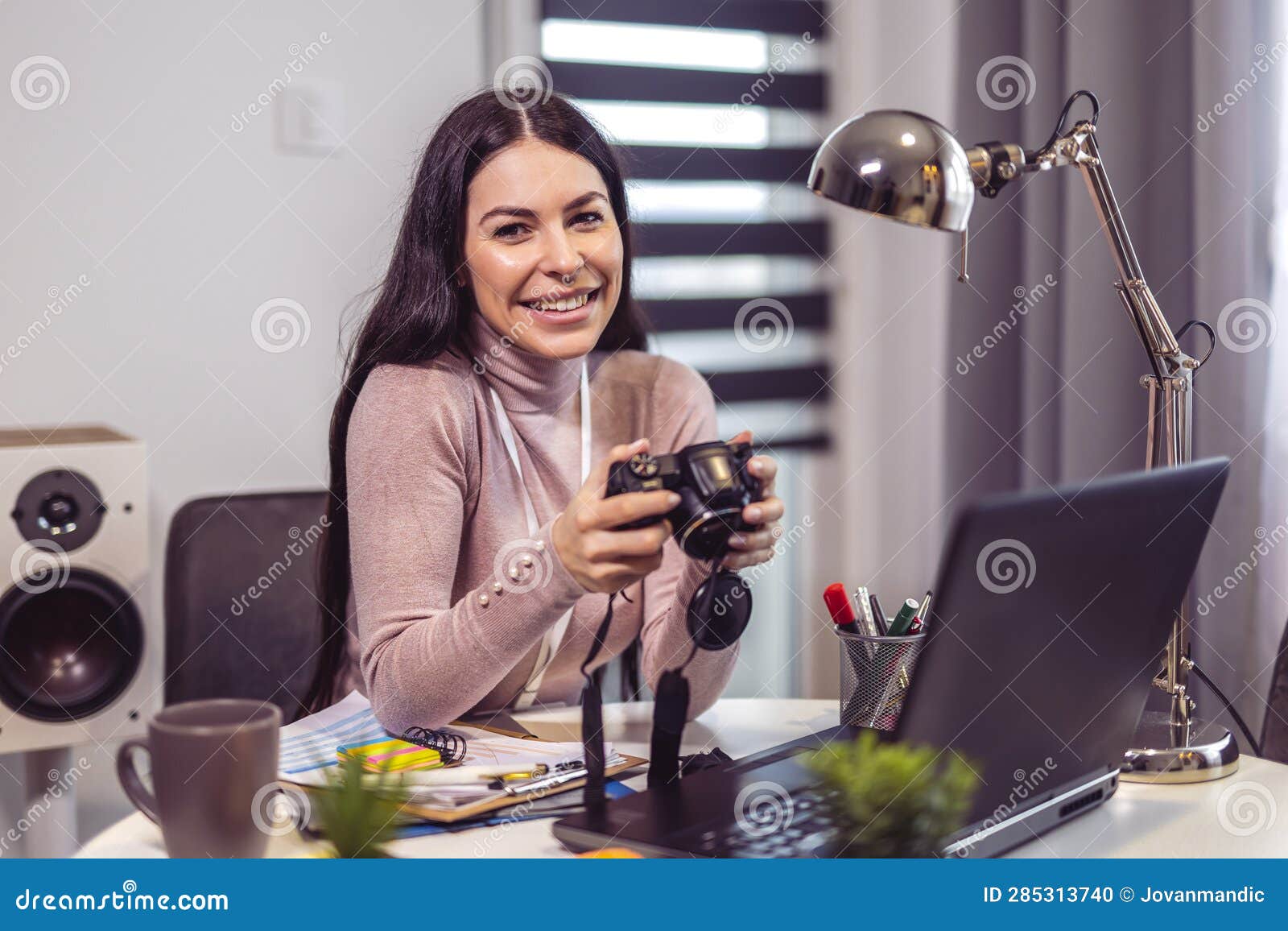 Woman Photographer Working with Laptop at the Working Place with ...