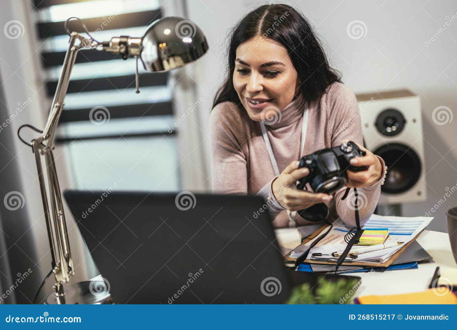 Woman Photographer Working with Laptop at the Working Place with ...