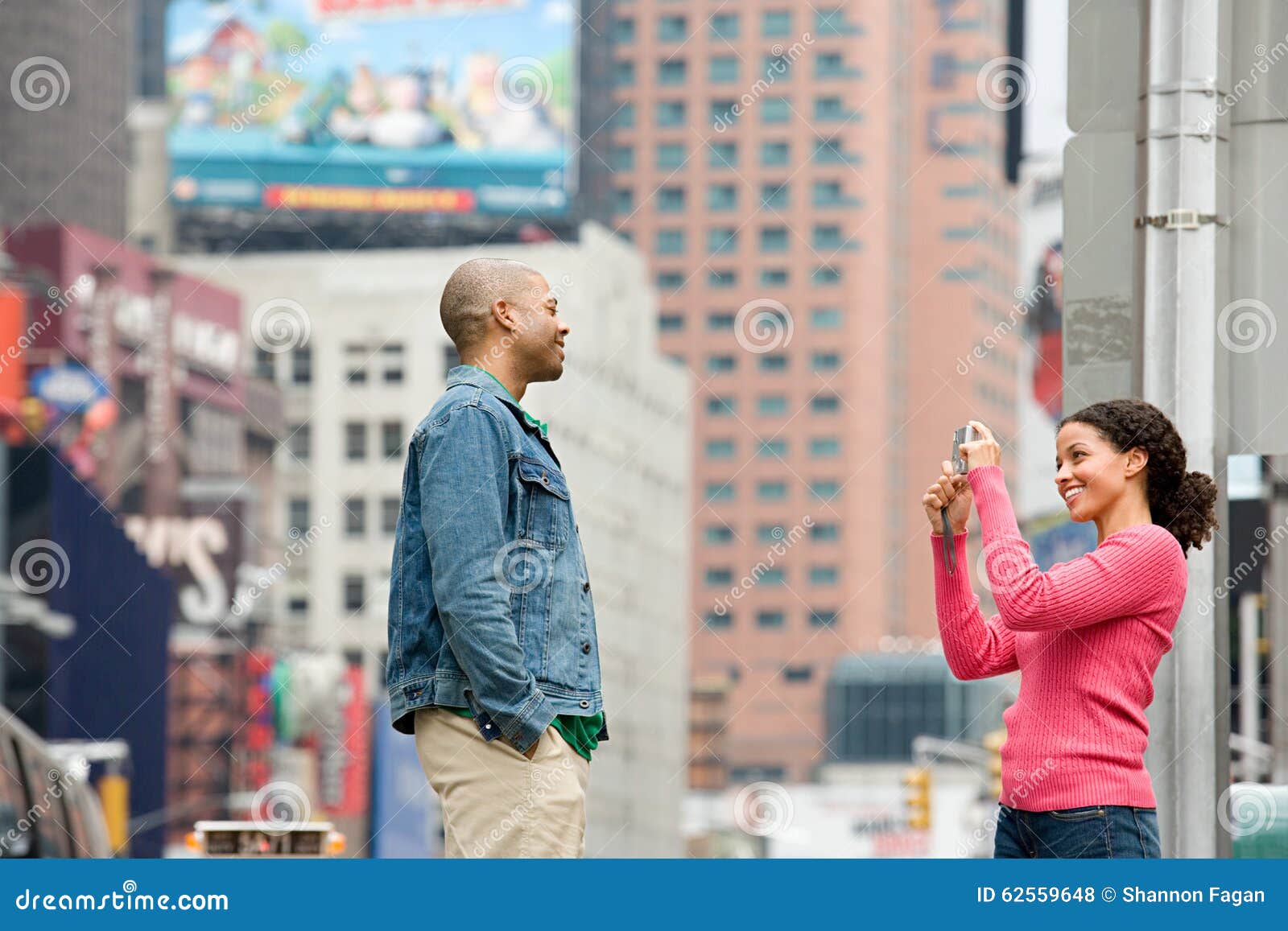 Woman photographing man stock photo. Image of building - 62559648