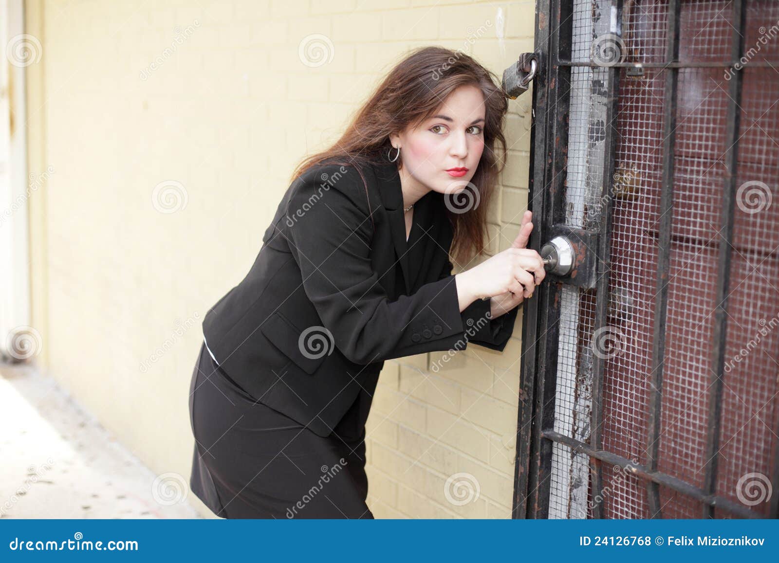 Woman picking the lock stock photo. Image of person, color - 24126768