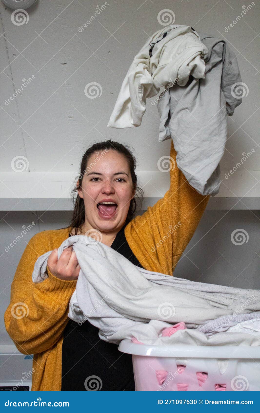 Woman with a Pile of Laundry Stock Photo - Image of table, smiling ...