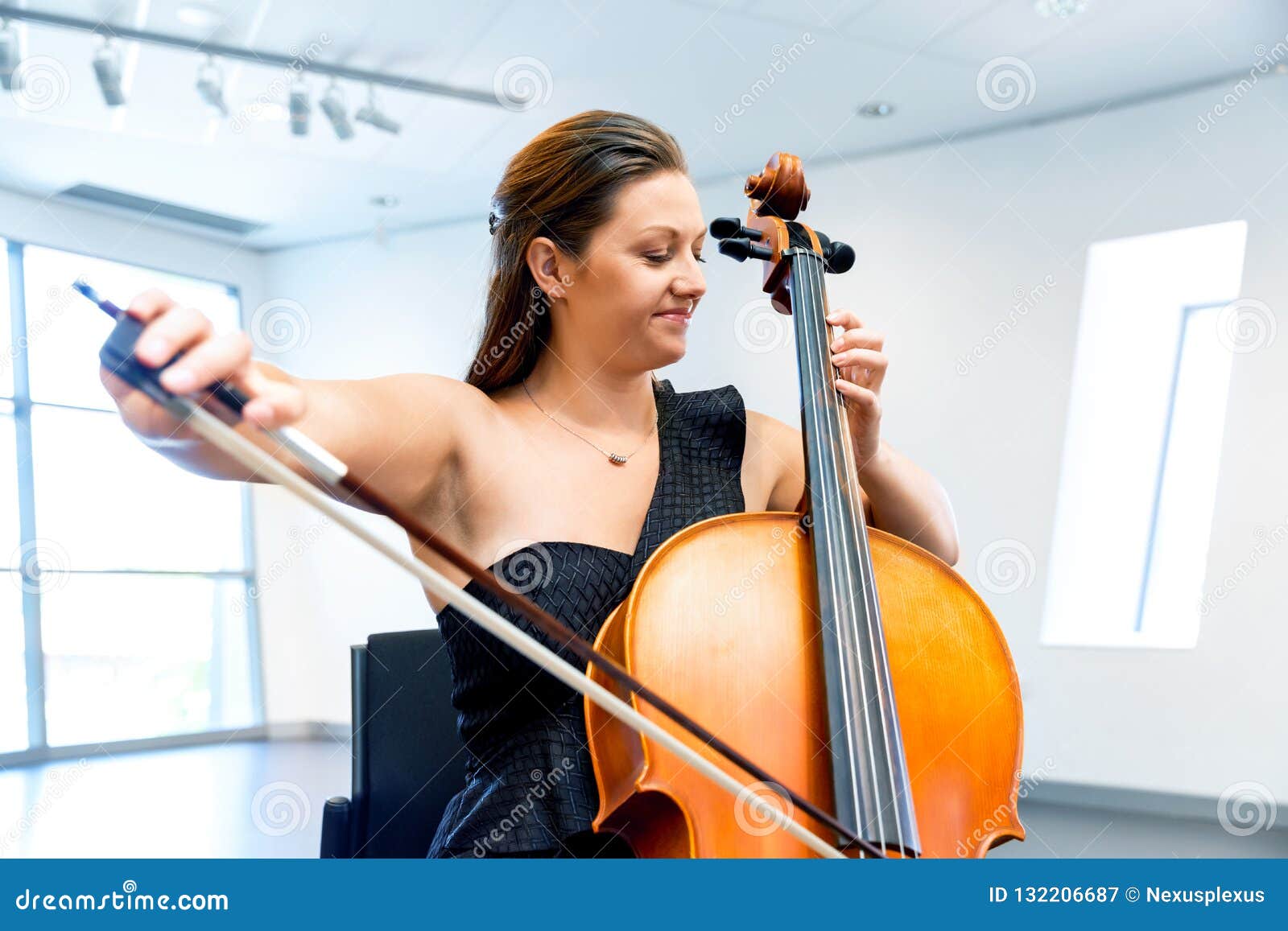 Woman playing cello stock image. Image of seat, cello - 132206687