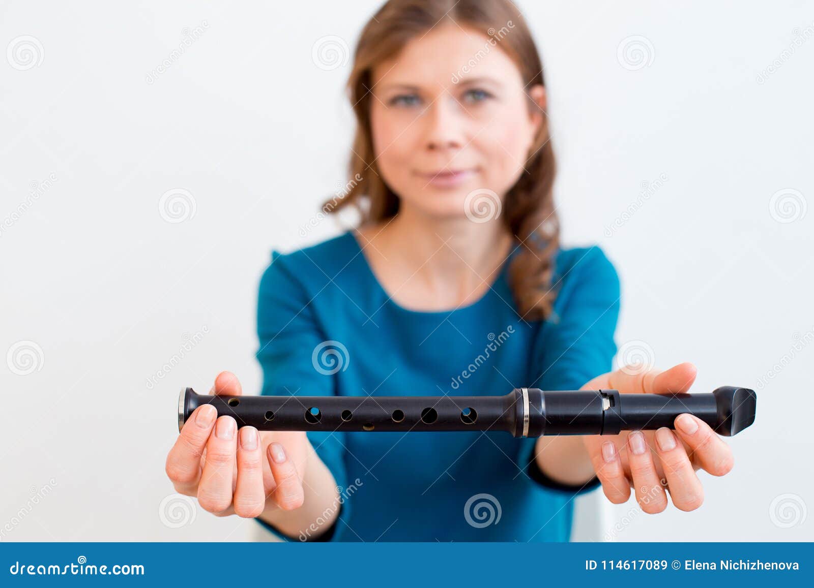 Woman playing on a flute stock image. Image of beauty - 114617089