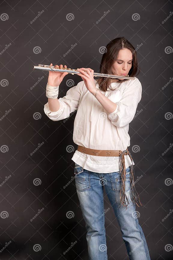 Woman playing the flute stock image. Image of beauty - 242522937