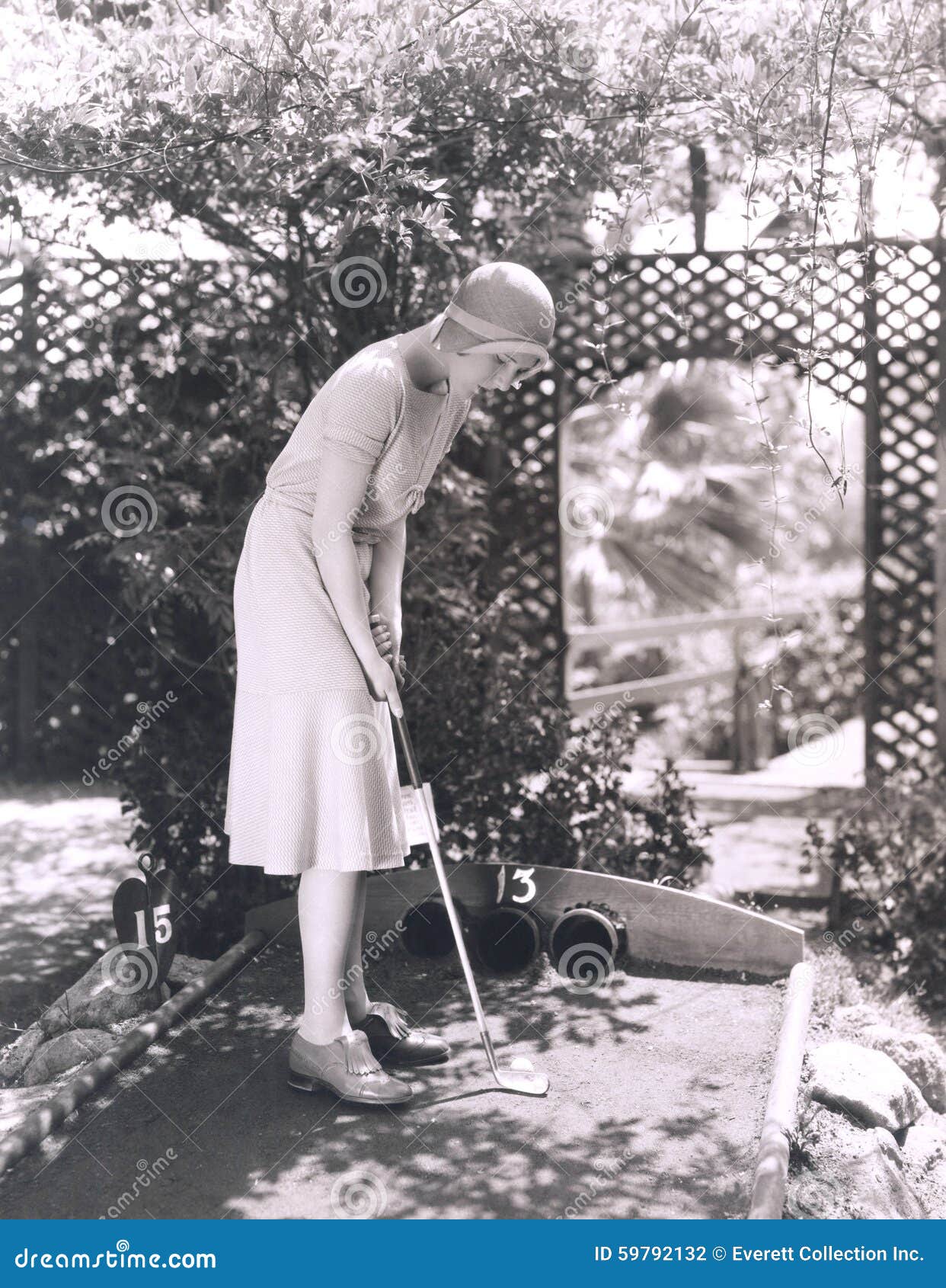 Woman Playing Miniature Golf Stock Photo - Image of cloche, ball: 59792132