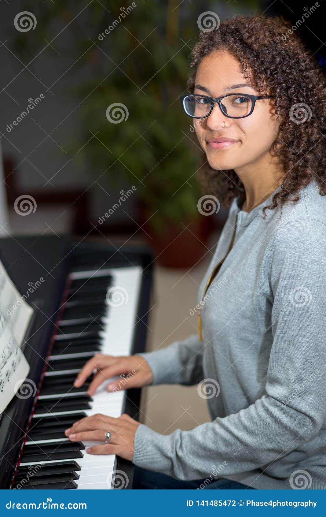 Woman playing piano stock photo. Image of electric, concert - 141485472