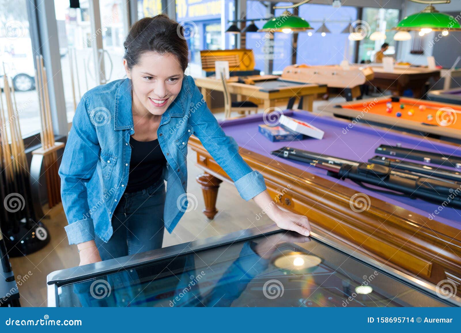 Woman Playing Pinball Machine Stock Photo - Image of establishment ...