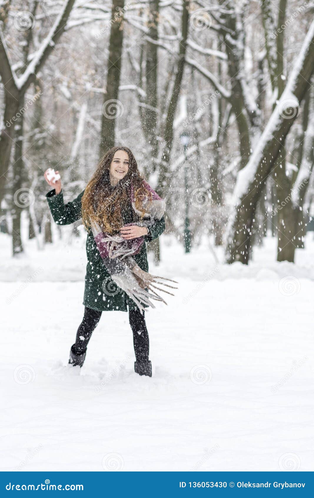 Woman playing snowballs stock photo. Image of person - 136053430
