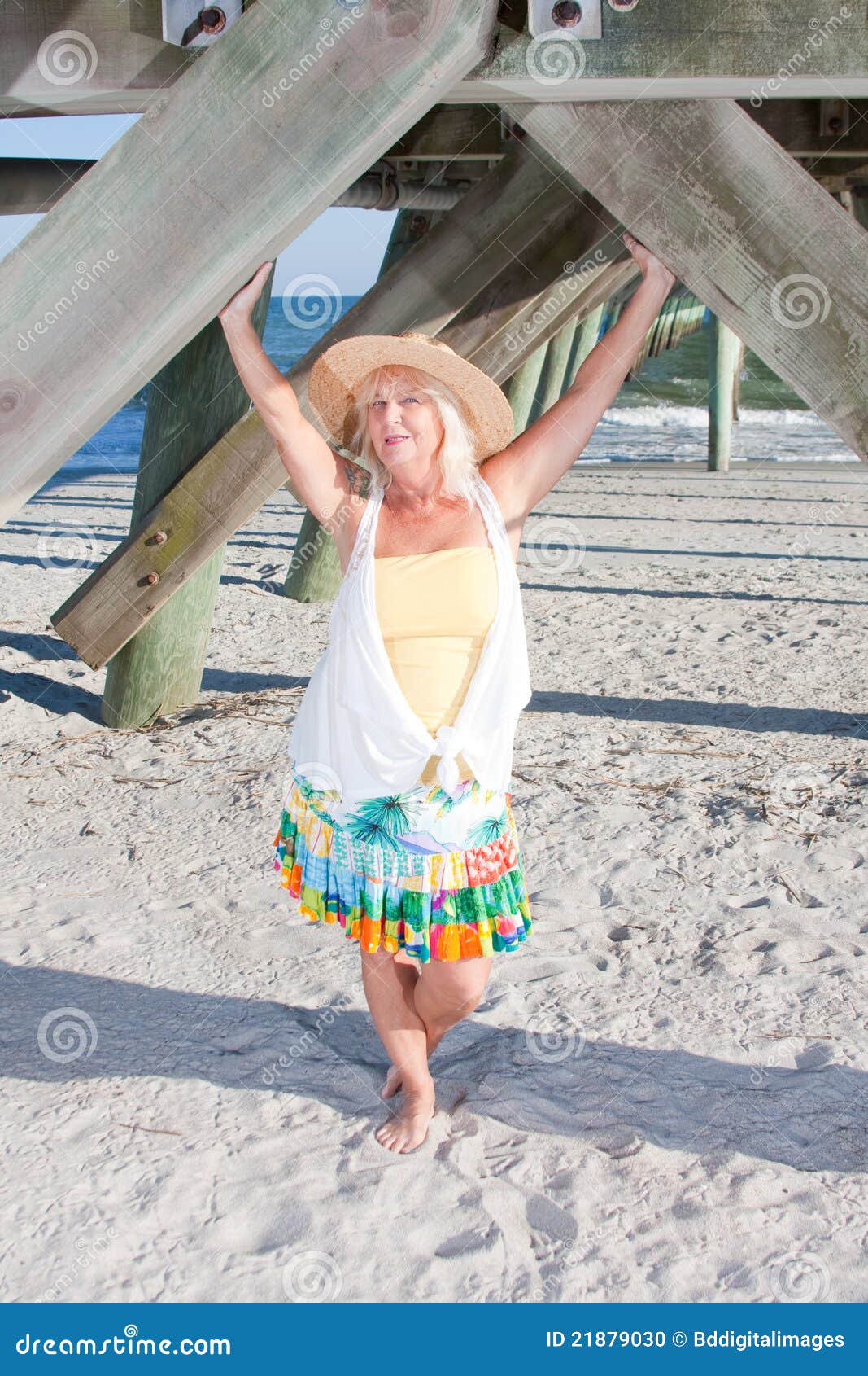 Woman Playing Under the Pier Stock Photo - Image of ocean, summer: 21879030