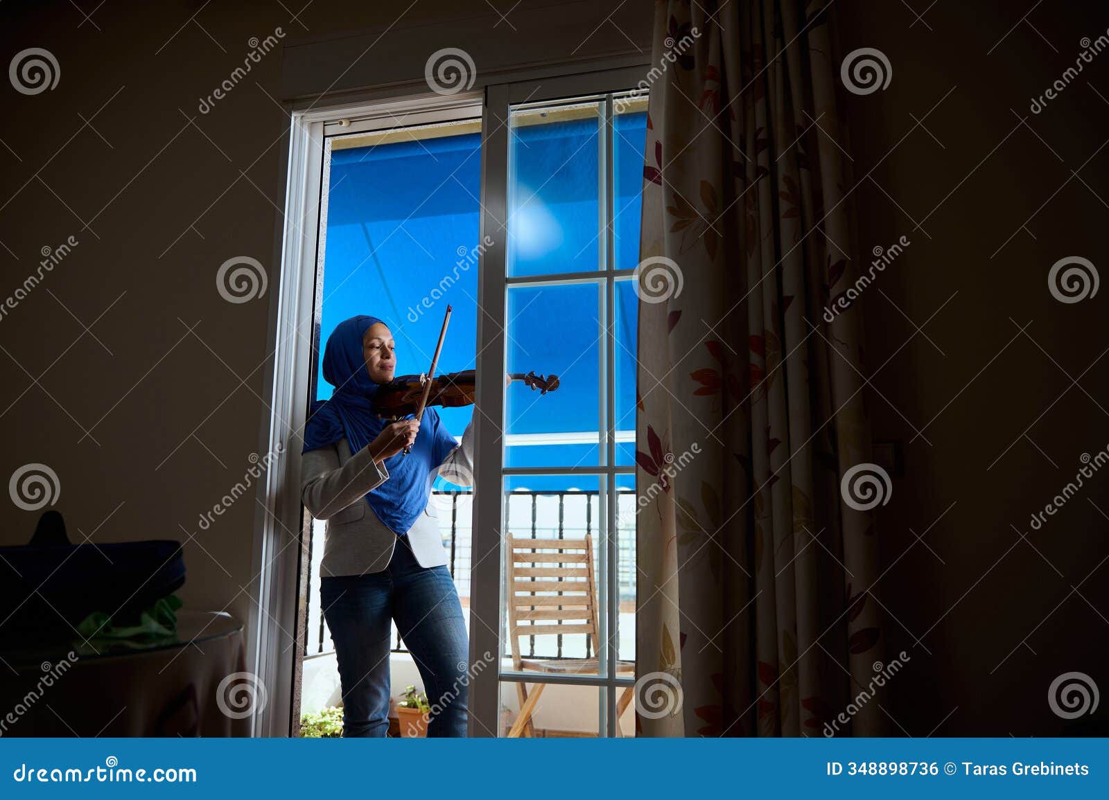 Woman Playing Violin by the Window with Natural Light Stock Photo ...