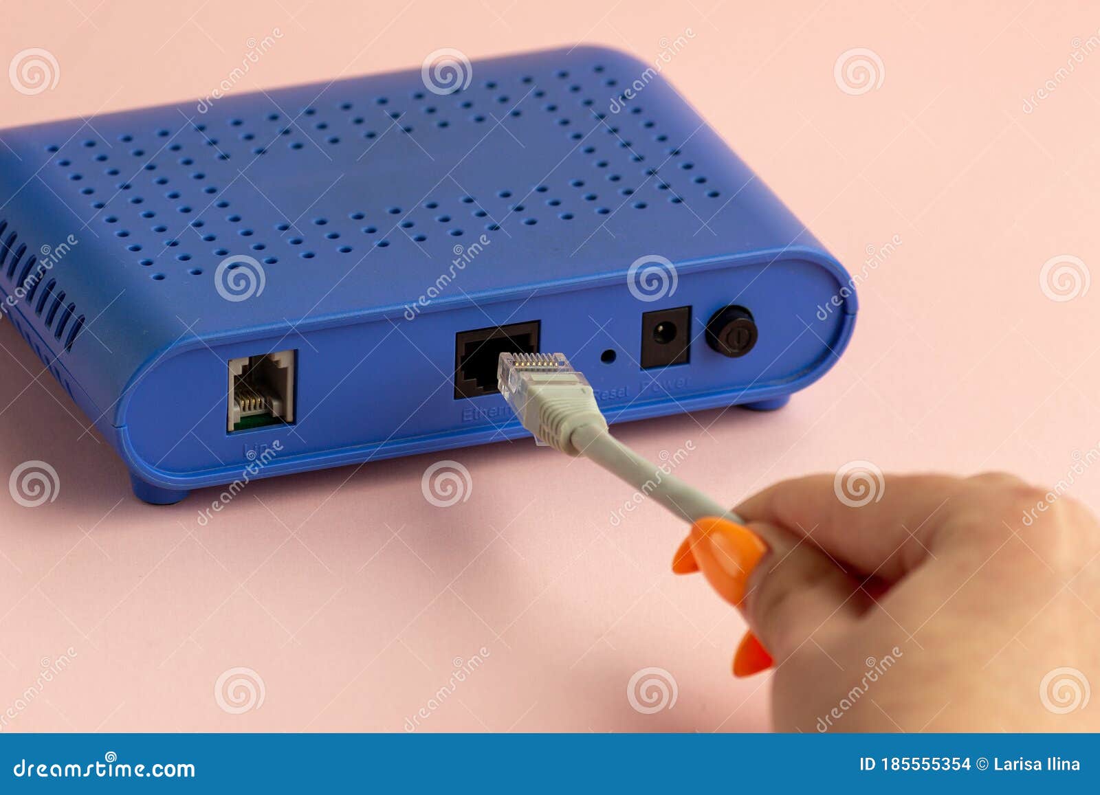 A Woman Plugs an Internet Cable into a Router. Ethernet Connection ...
