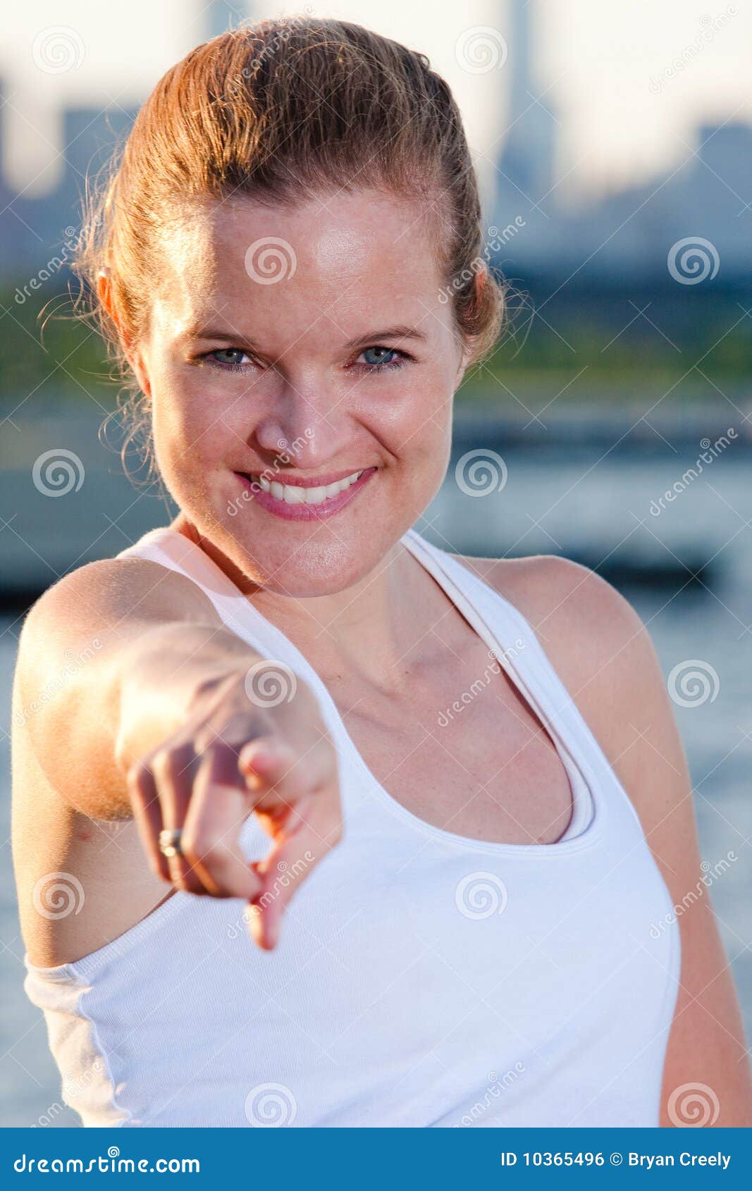 Woman pointing at camera stock photo. Image of fitness - 10365496