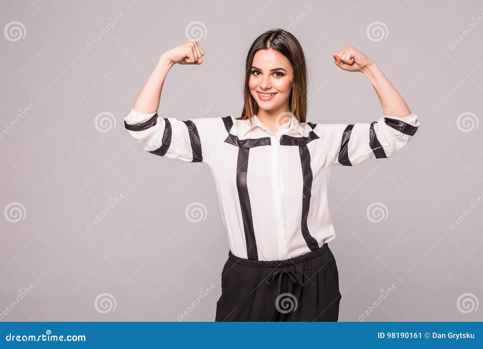 Young Woman Points To the Strong Hands on a Gray Stock Image - Image of ...