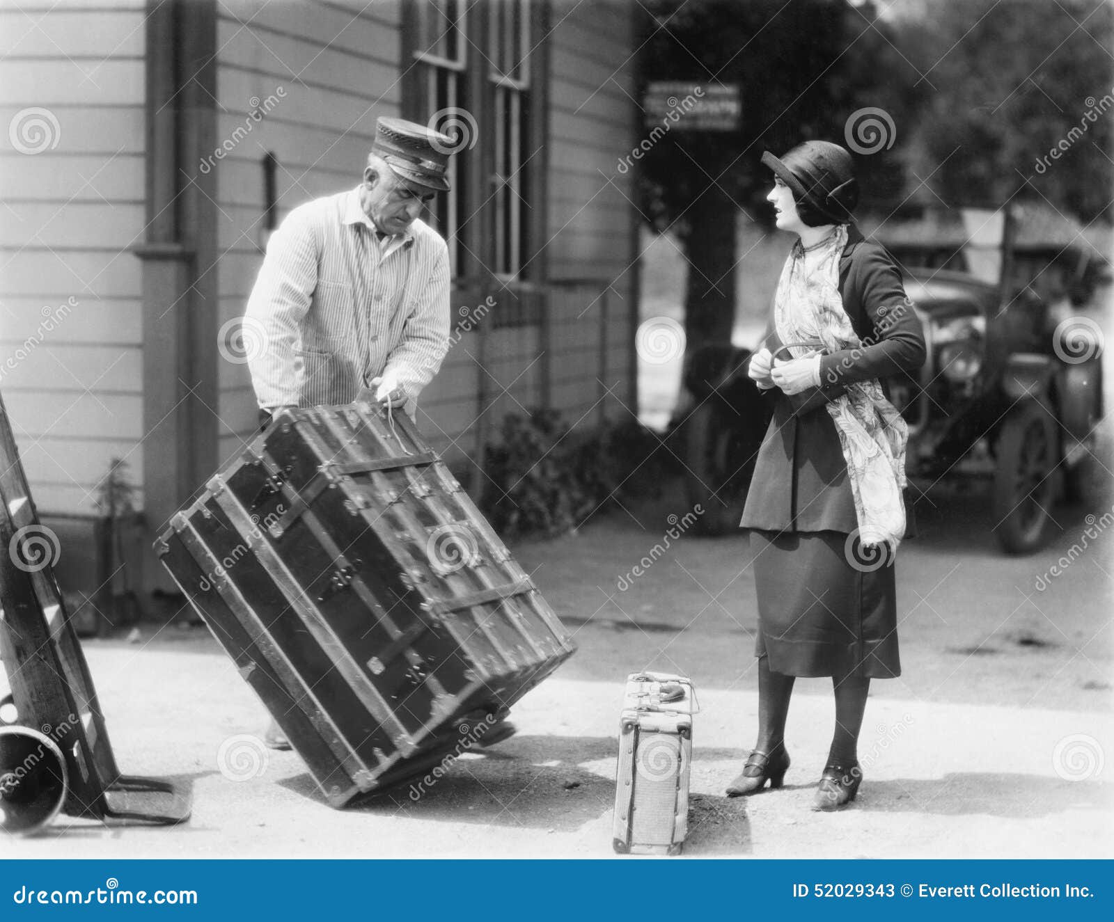 Woman and a Porter Carrying Her Trunk Stock Image - Image of assisting ...
