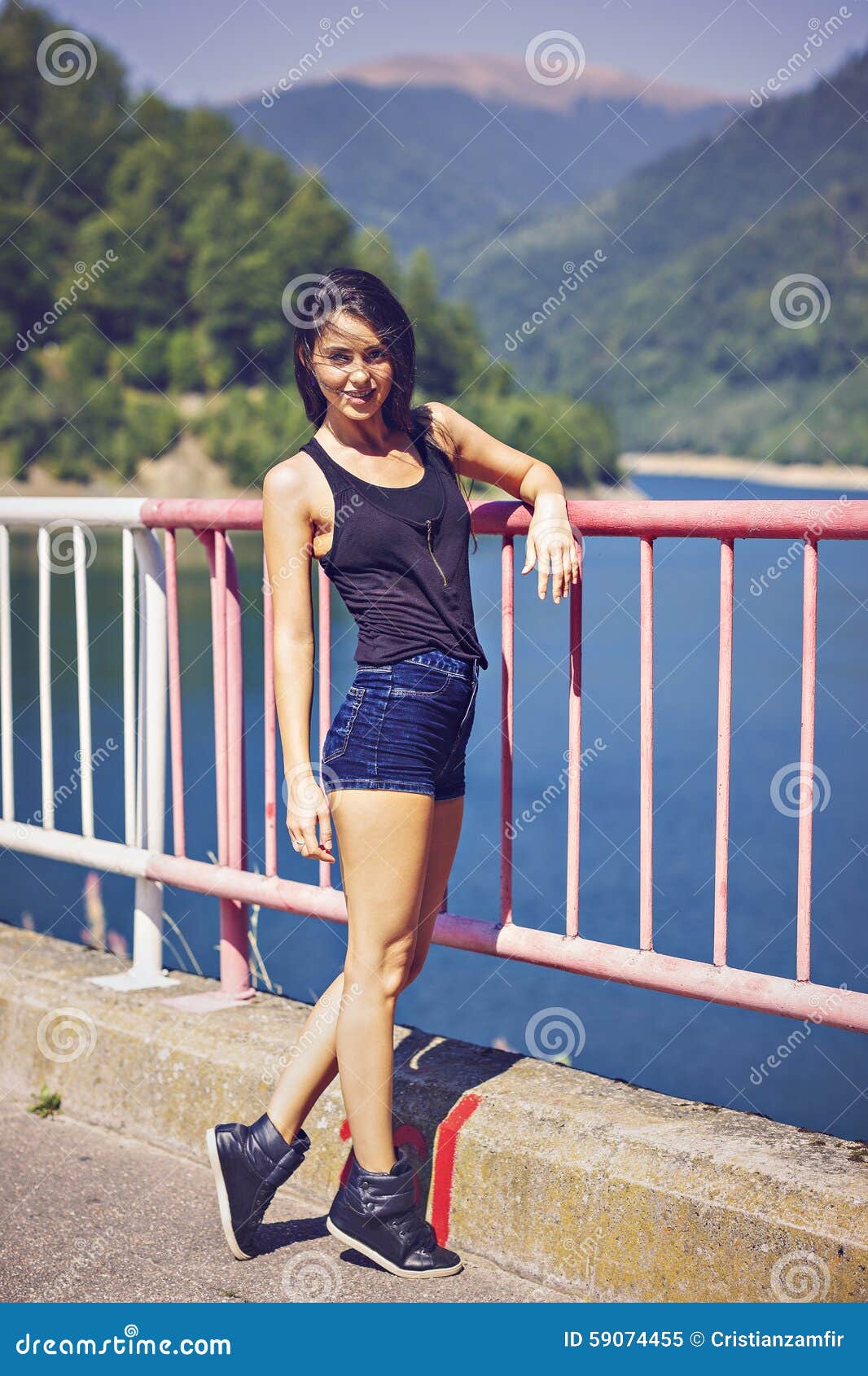 Woman posing on a bridge stock image. Image of model - 59074455