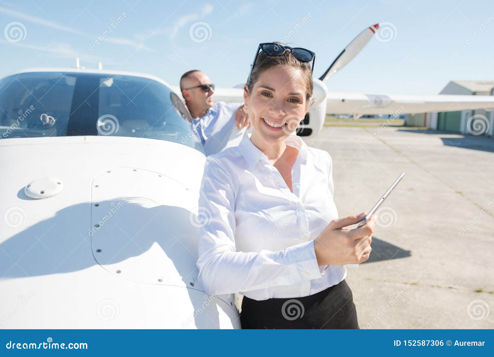 Woman Posing Next To Private Plane Stock Photo - Image of pilot, smile ...