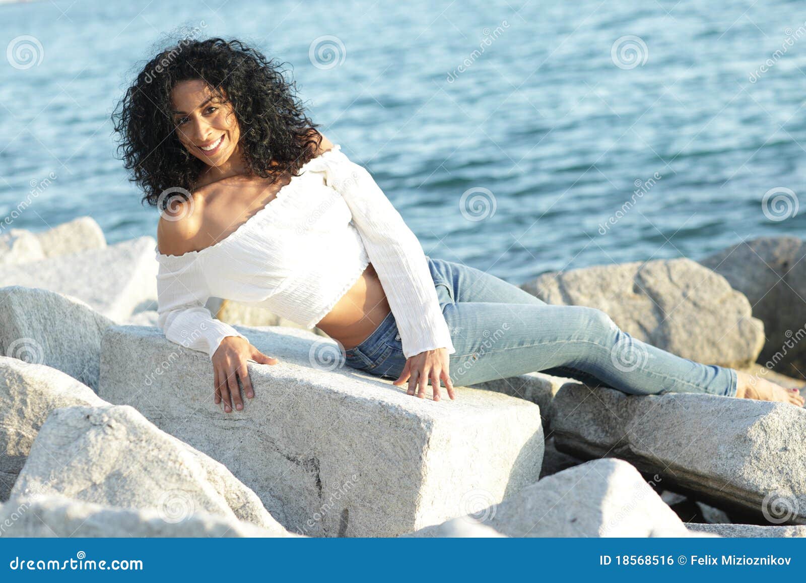 Woman posing on the rocks stock photo. Image of pretty - 18568516