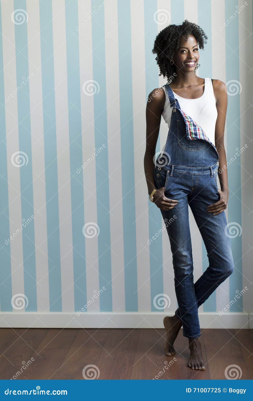 Woman posing by the wall stock image. Image of model - 71007725