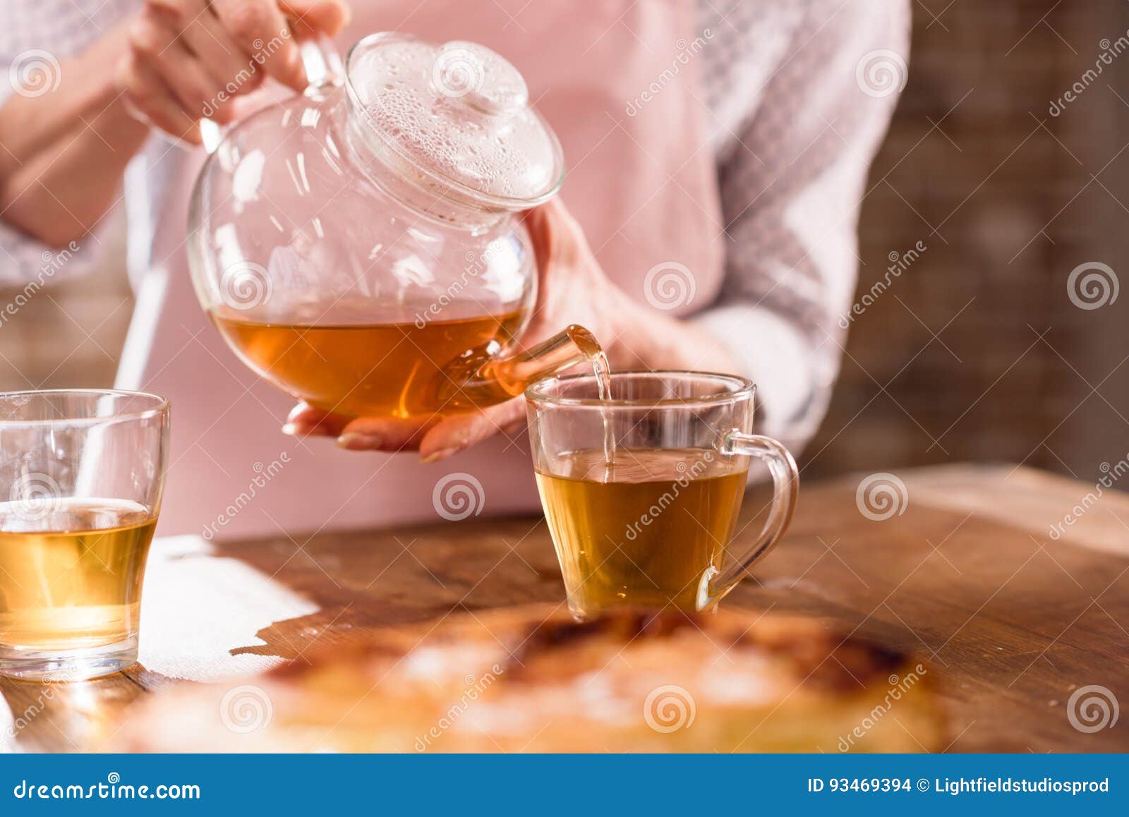 Woman pouring hot tea stock photo. Image of woman, hands - 93469394