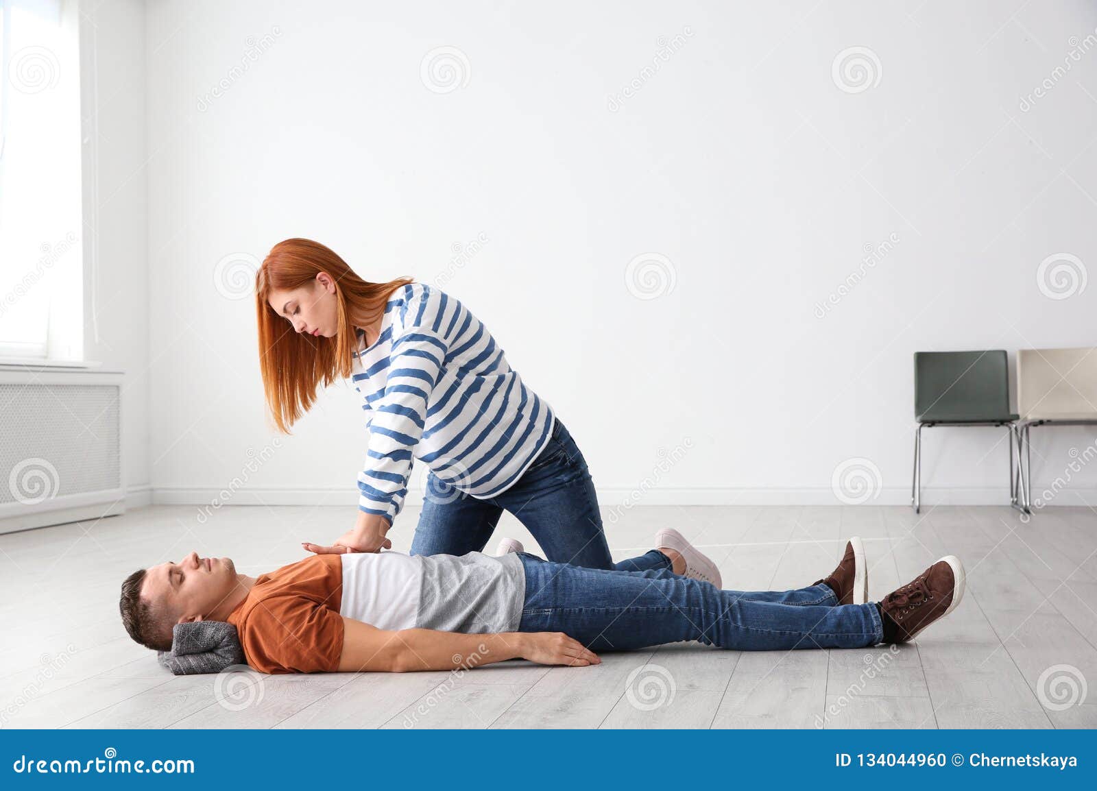 Woman Practicing First Aid on Unconscious Man Stock Photo - Image of ...