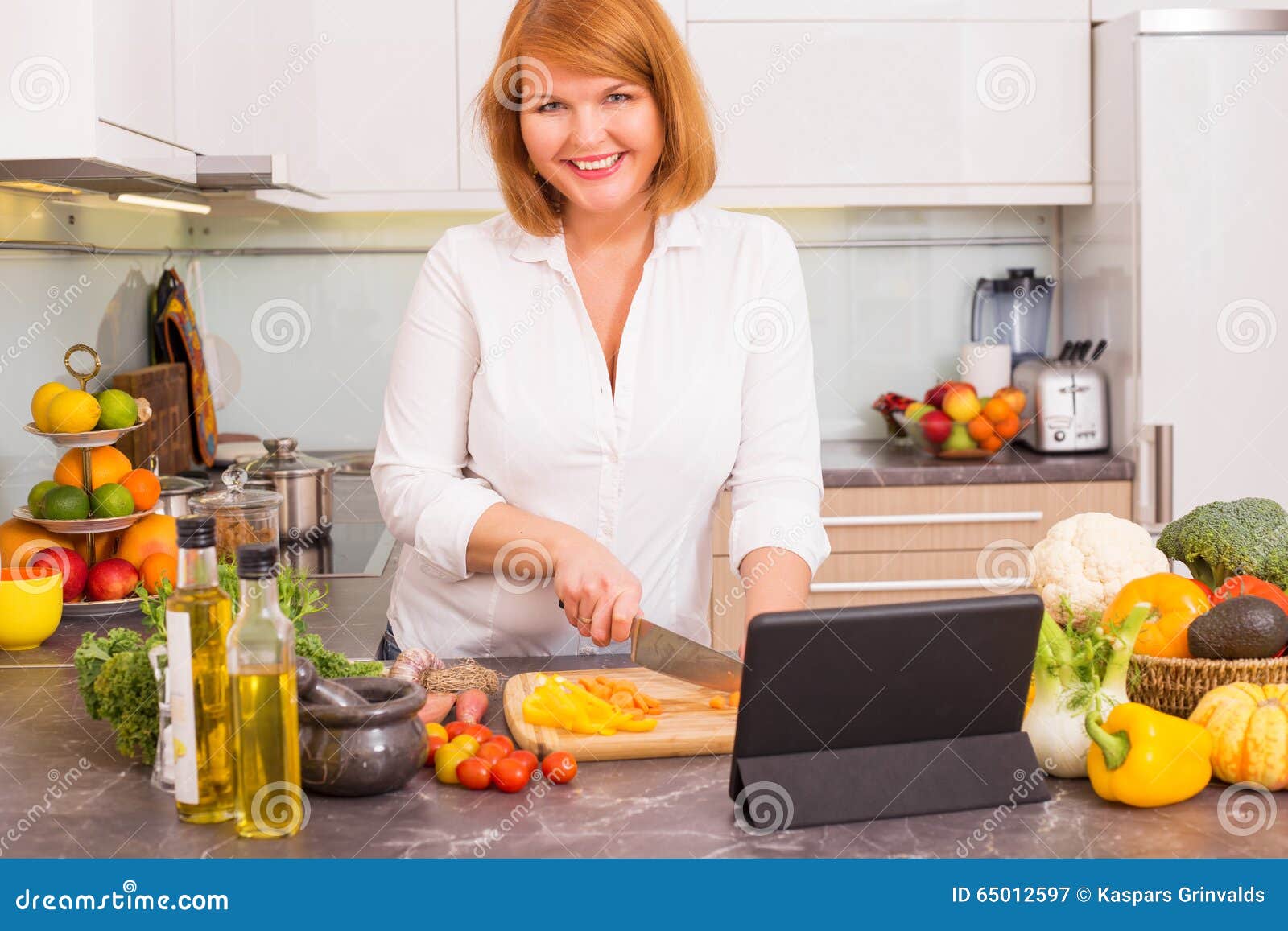 Woman Preparing Dinner from Recipe in Tablet Stock Image - Image of ...