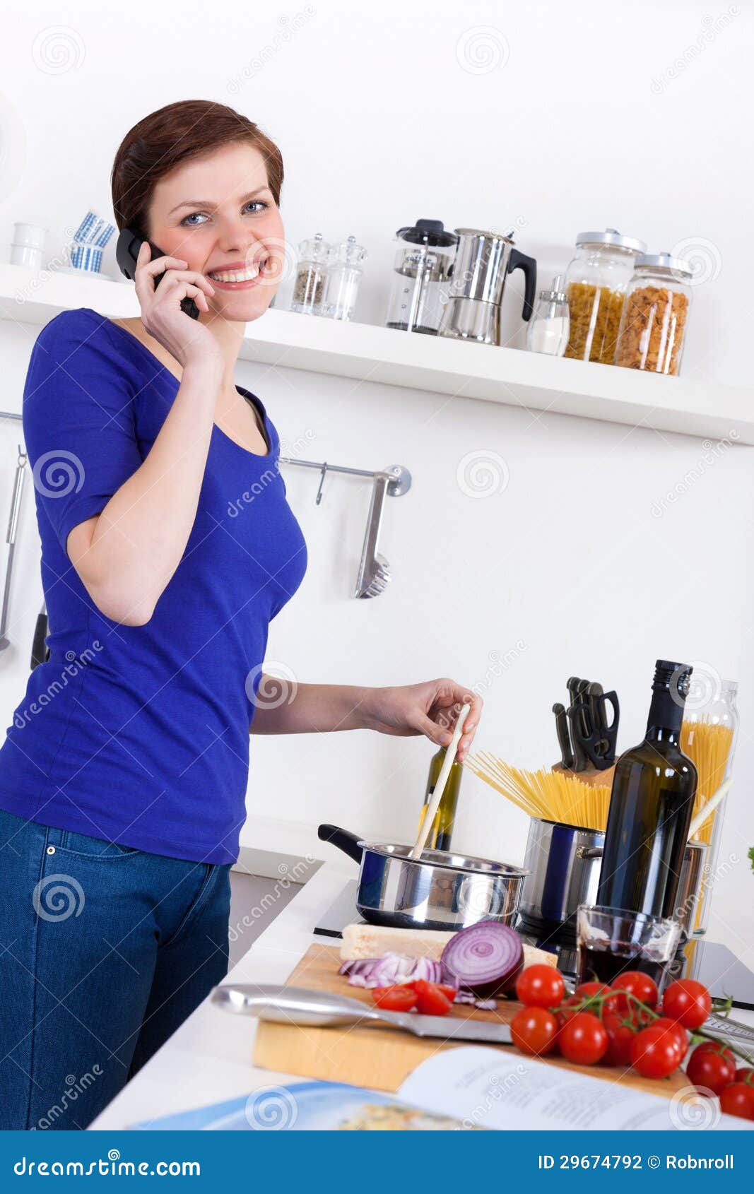 Woman Preparing Pasta Dish and Talking on the Phone Stock Photo - Image ...