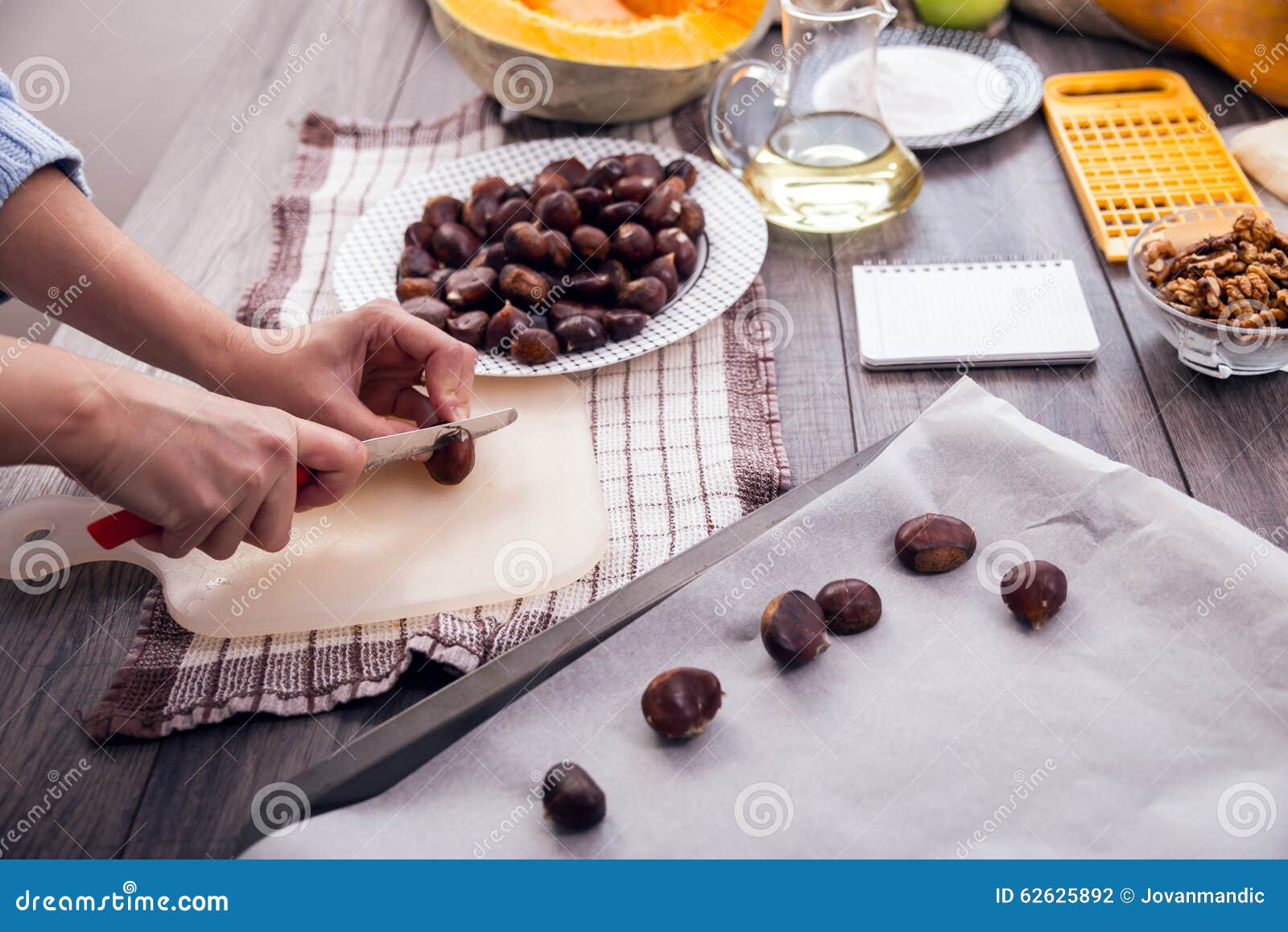 Woman Preparing Sweet Chestnuts for Roasting in Oven Stock Photo ...