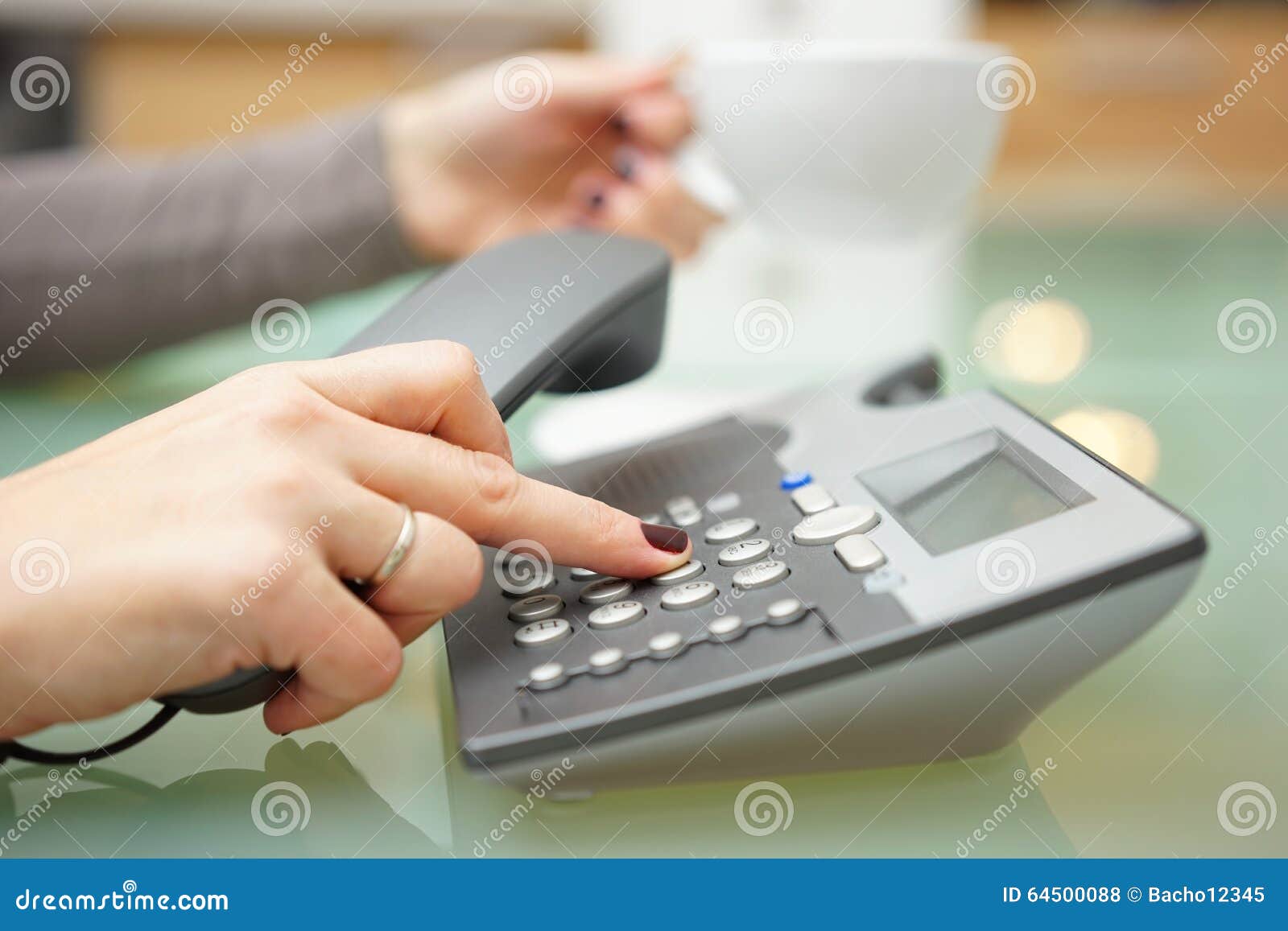 Woman is Pressing Button on on the Phone Dial Pad and Drinking C Stock ...